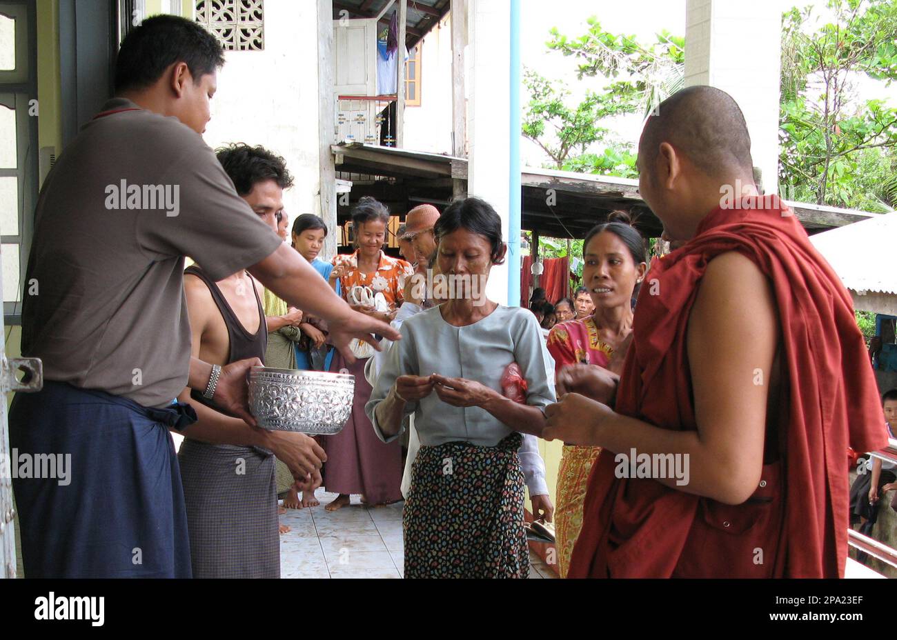Monks donate cooking pots and woks to cyclone survivors at Magay ...