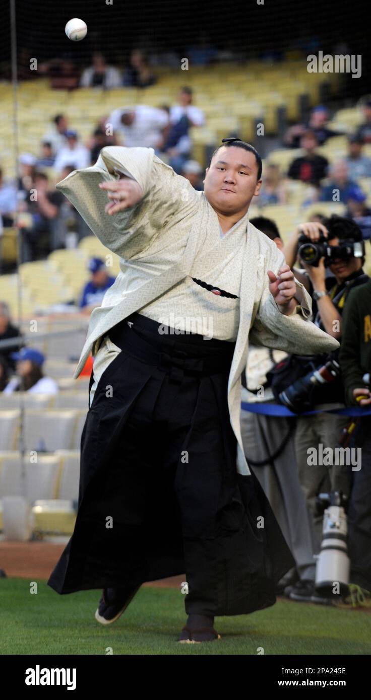 Mongolian sumo wrester Hakuho throws a baseball before a Major League ...
