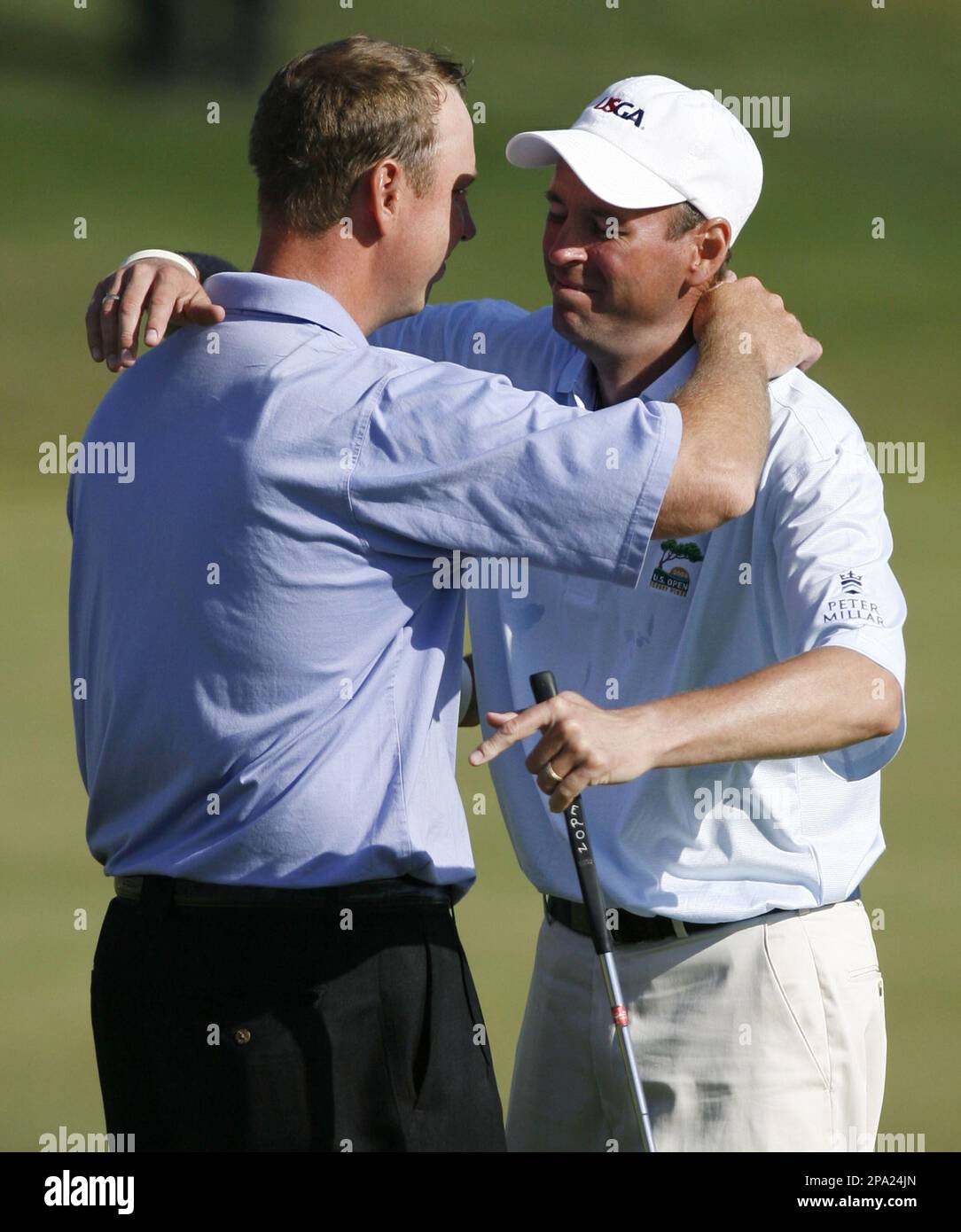 John Atkinson, right, is hugged by his brother Kevin Atkinson, left ...