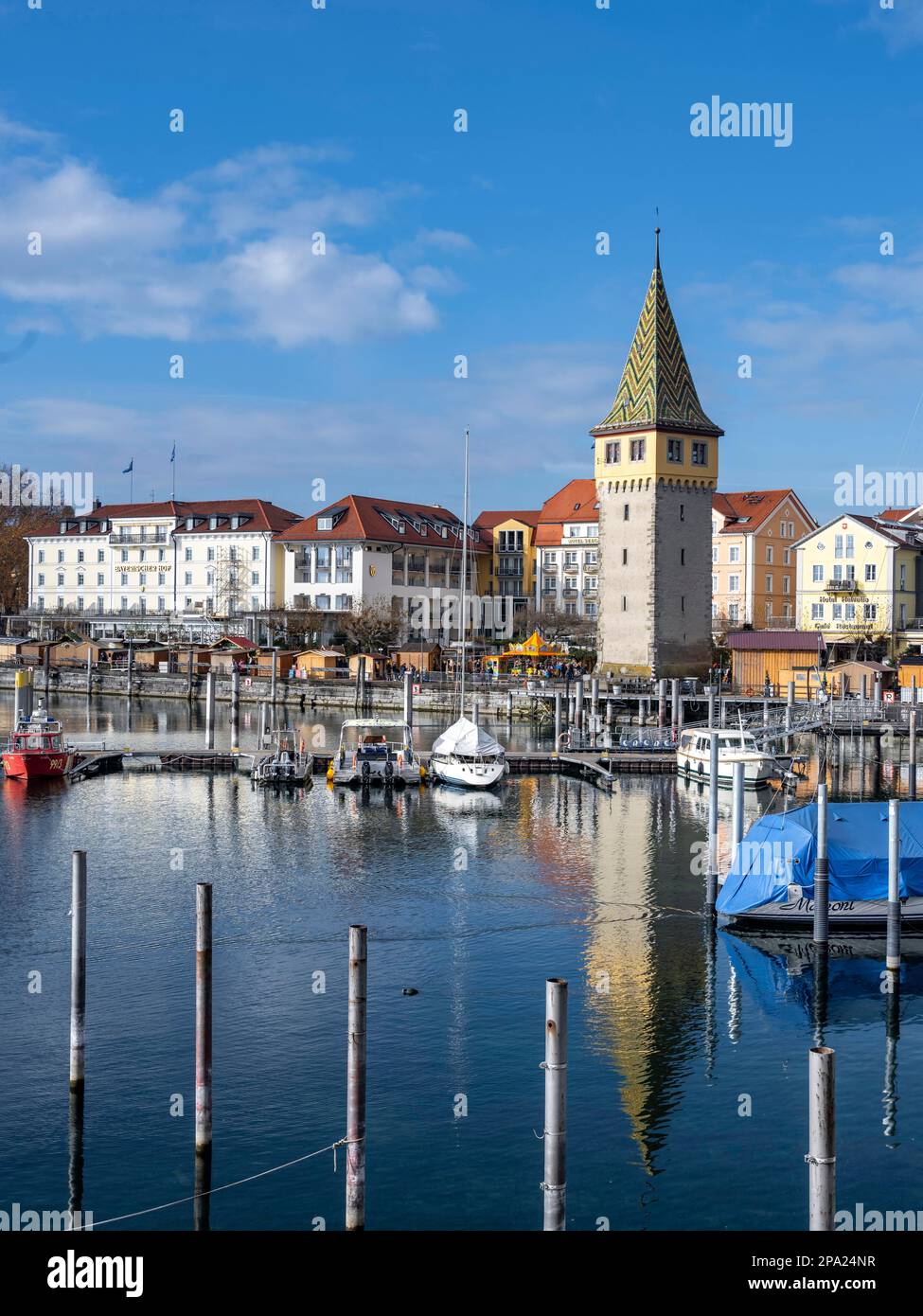 Sailboats in the harbour, harbour promenade with Mangturm, reflected in ...