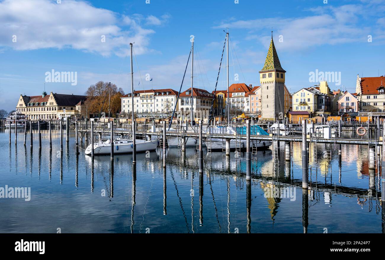 Sailboats in the harbour, harbour promenade with Mangturm, reflected in ...