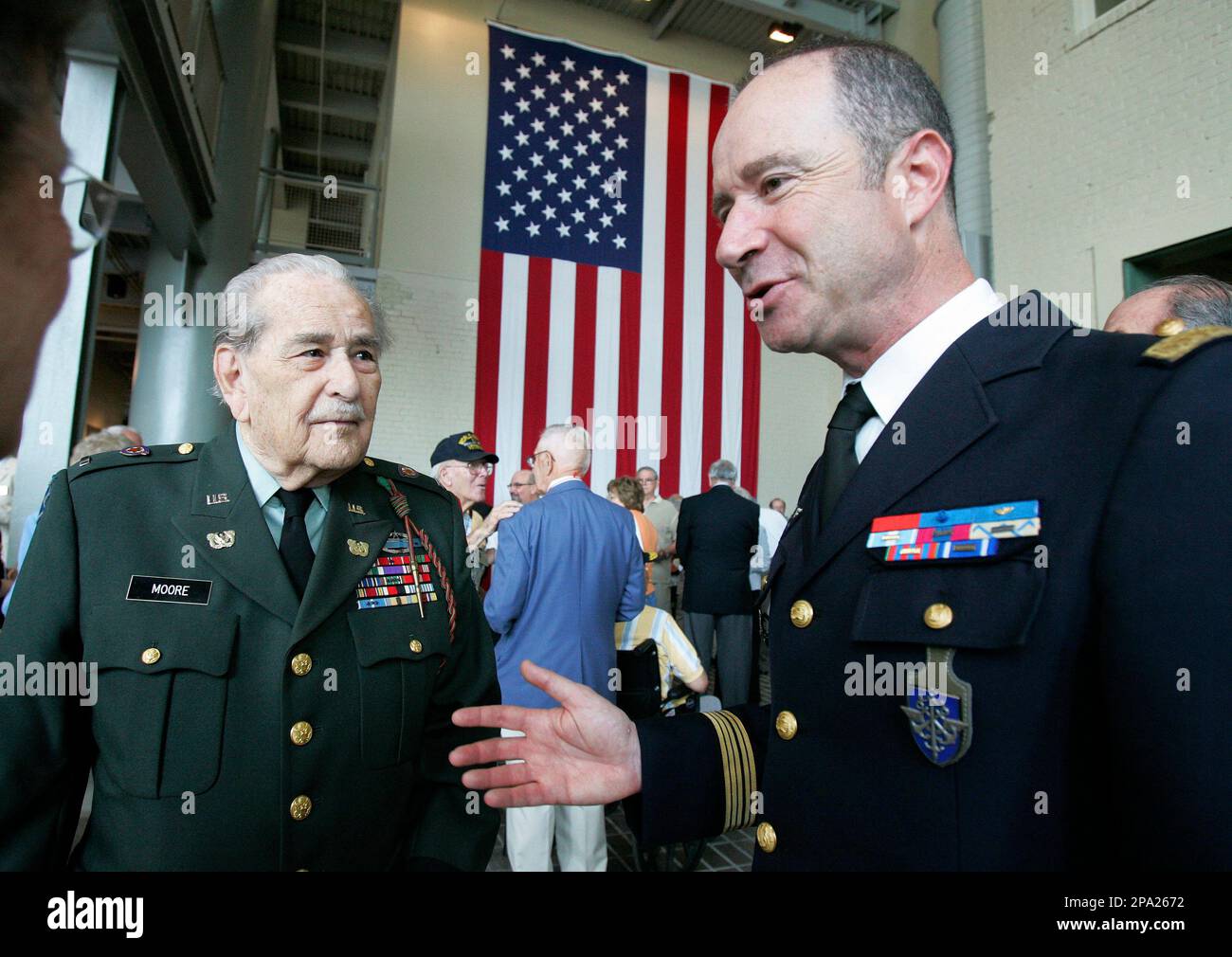 Army D-Day veteran William L. Moore, left, talks with French Air Force ...
