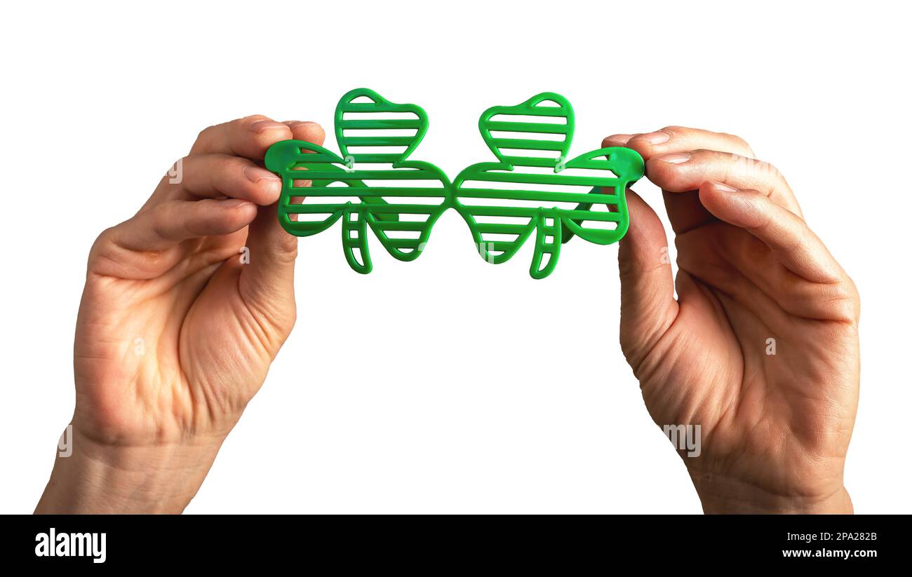 Clover-shaped glasses, green leaf eyewear, eye decoration in hands ...