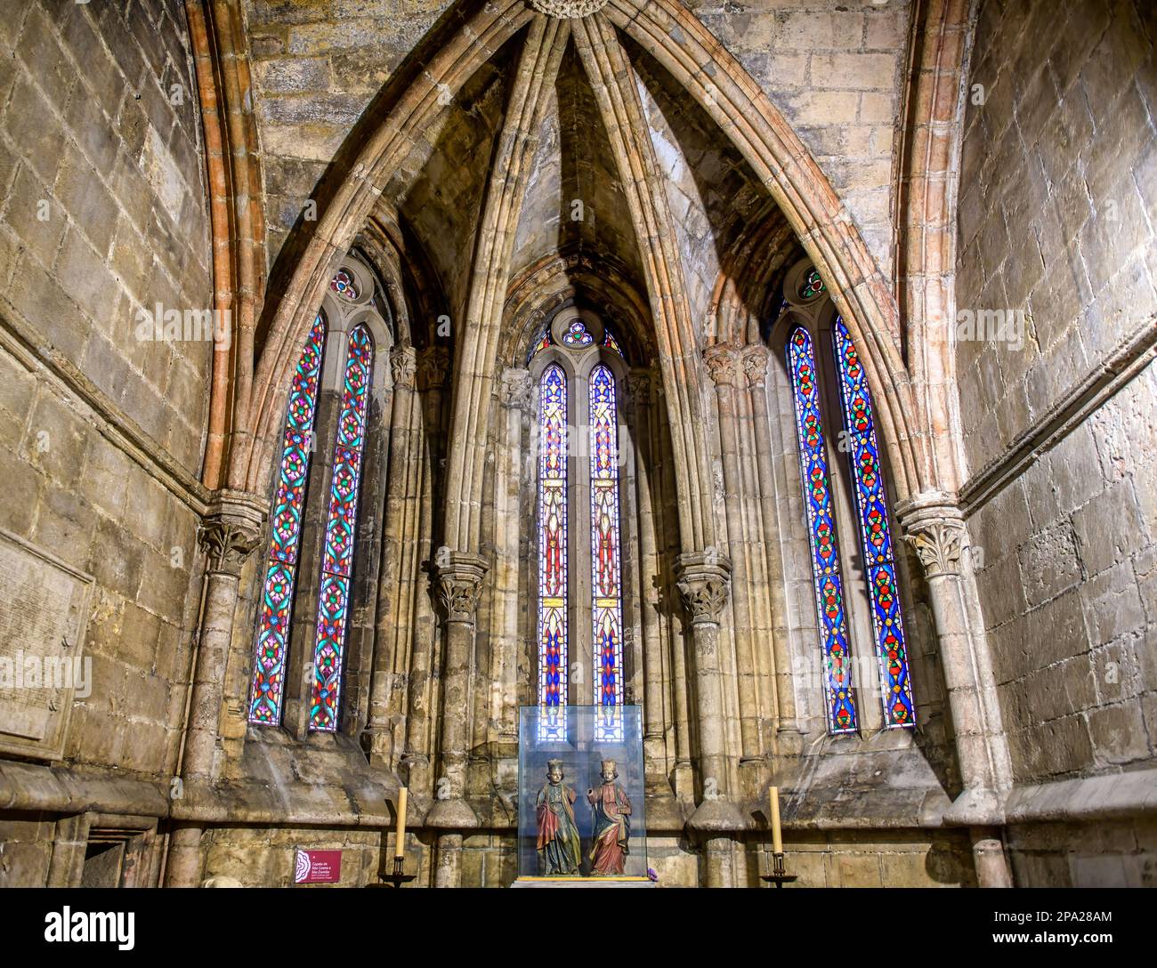 Three stained glass windows in a stone arched chapel. Architecture ...