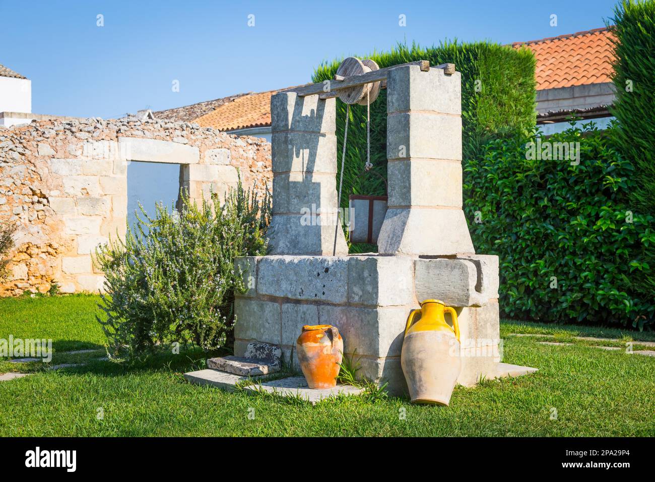 Summer season in Italy. Desing water well in an elegant garden Stock ...