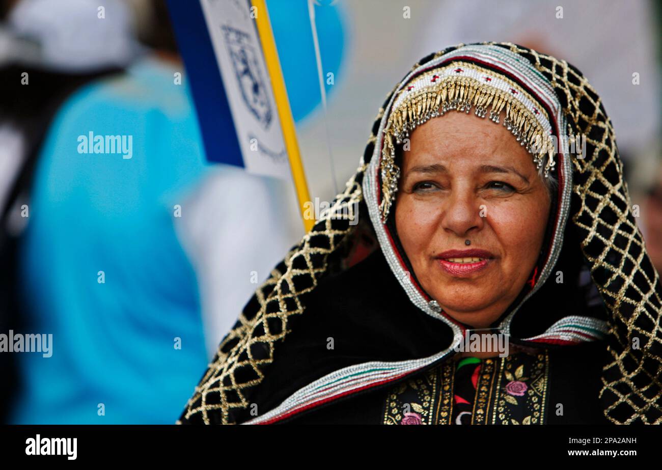A Jewish Israeli woman dressed in traditional clothes waits for the ...