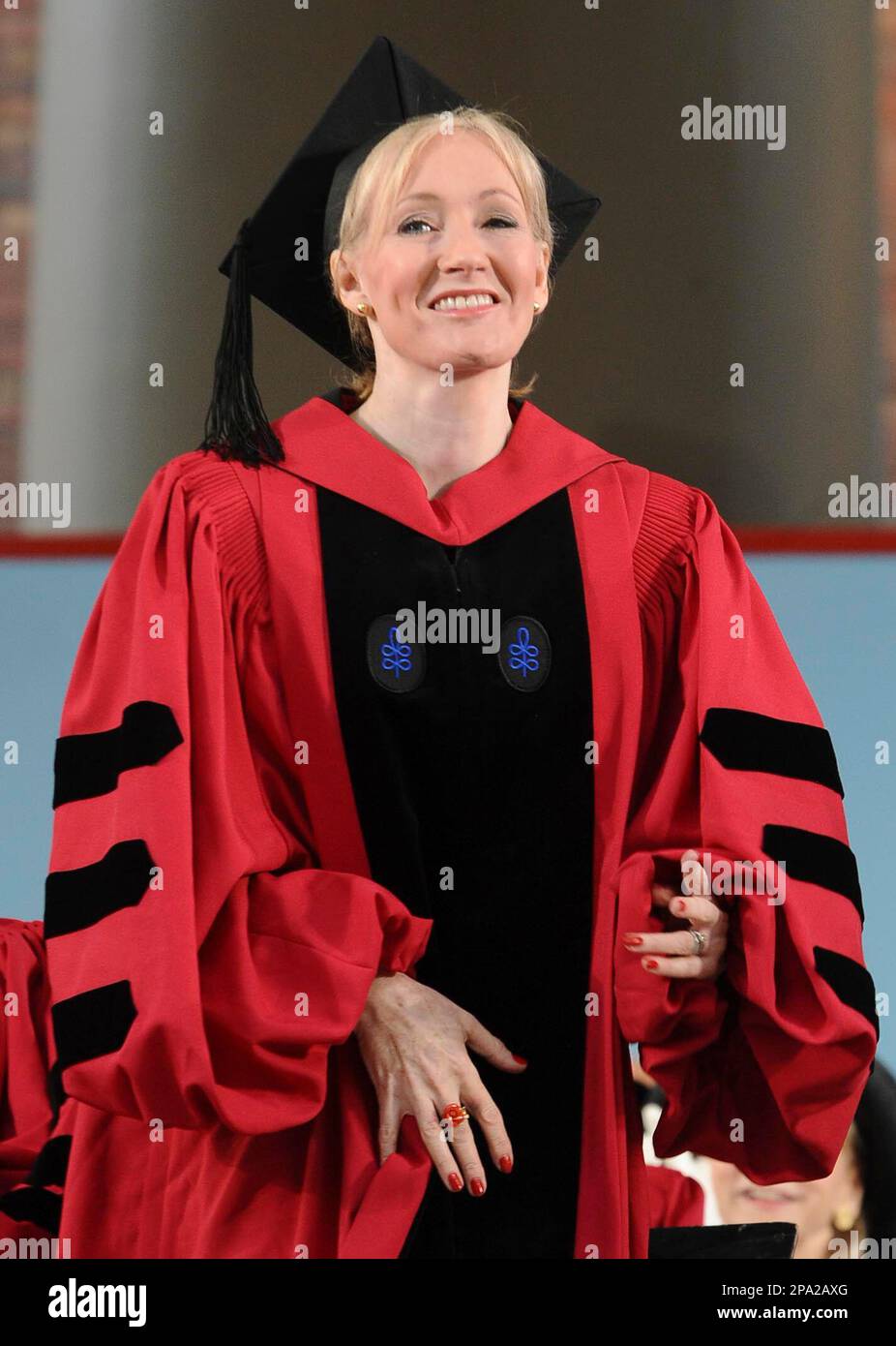 Author J.K. Rowling smiles as she stands for an honorary degree during ...