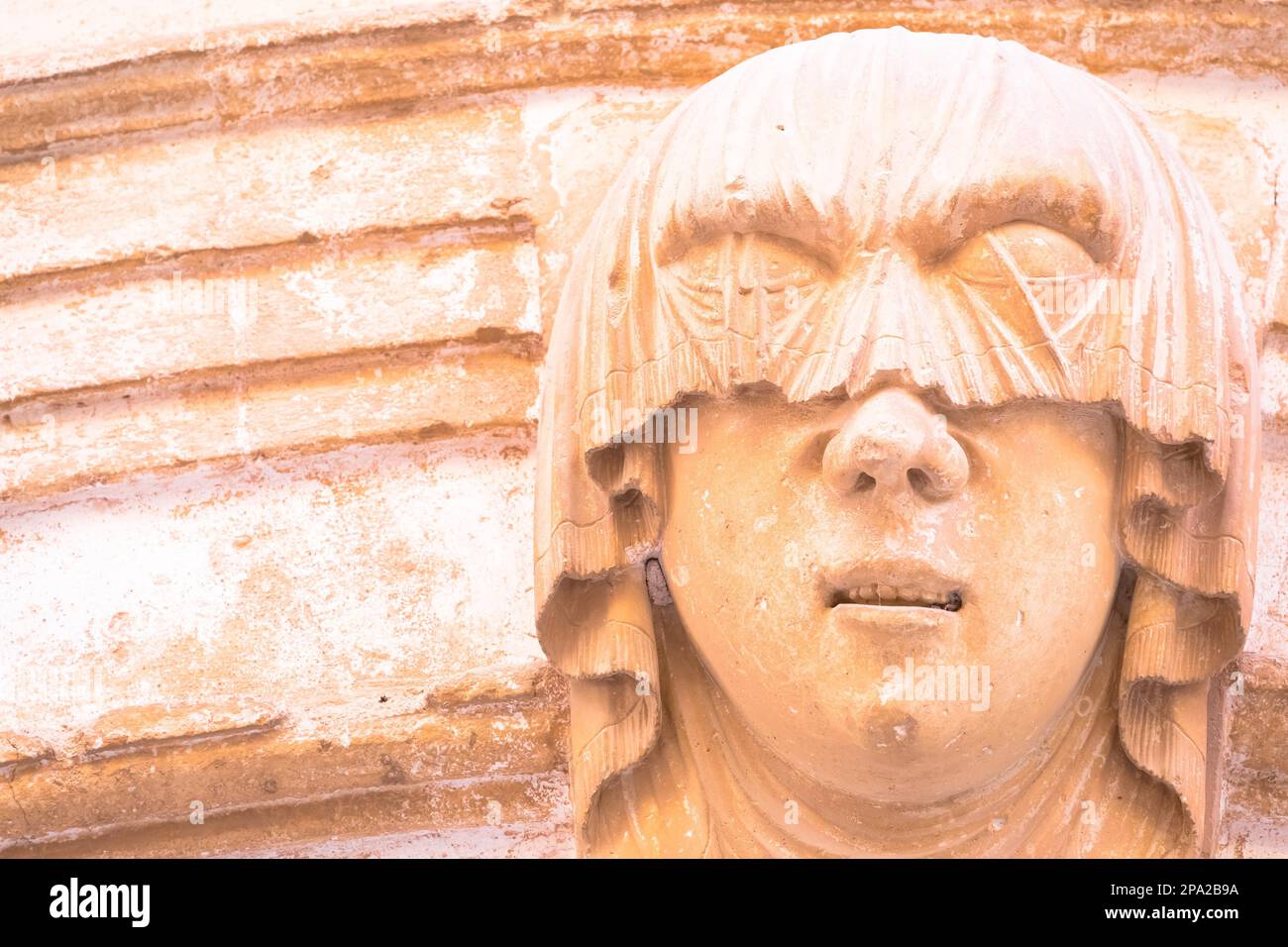 Gothic detail. Young woman portrait at the entrance of a 200 years old ...
