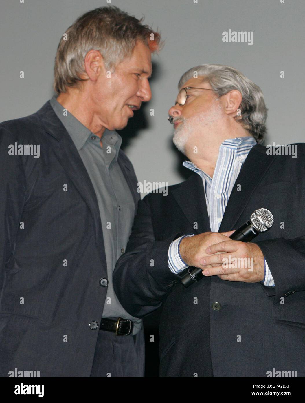 Actor Harrison Ford, left, chats with executive producer and writer ...