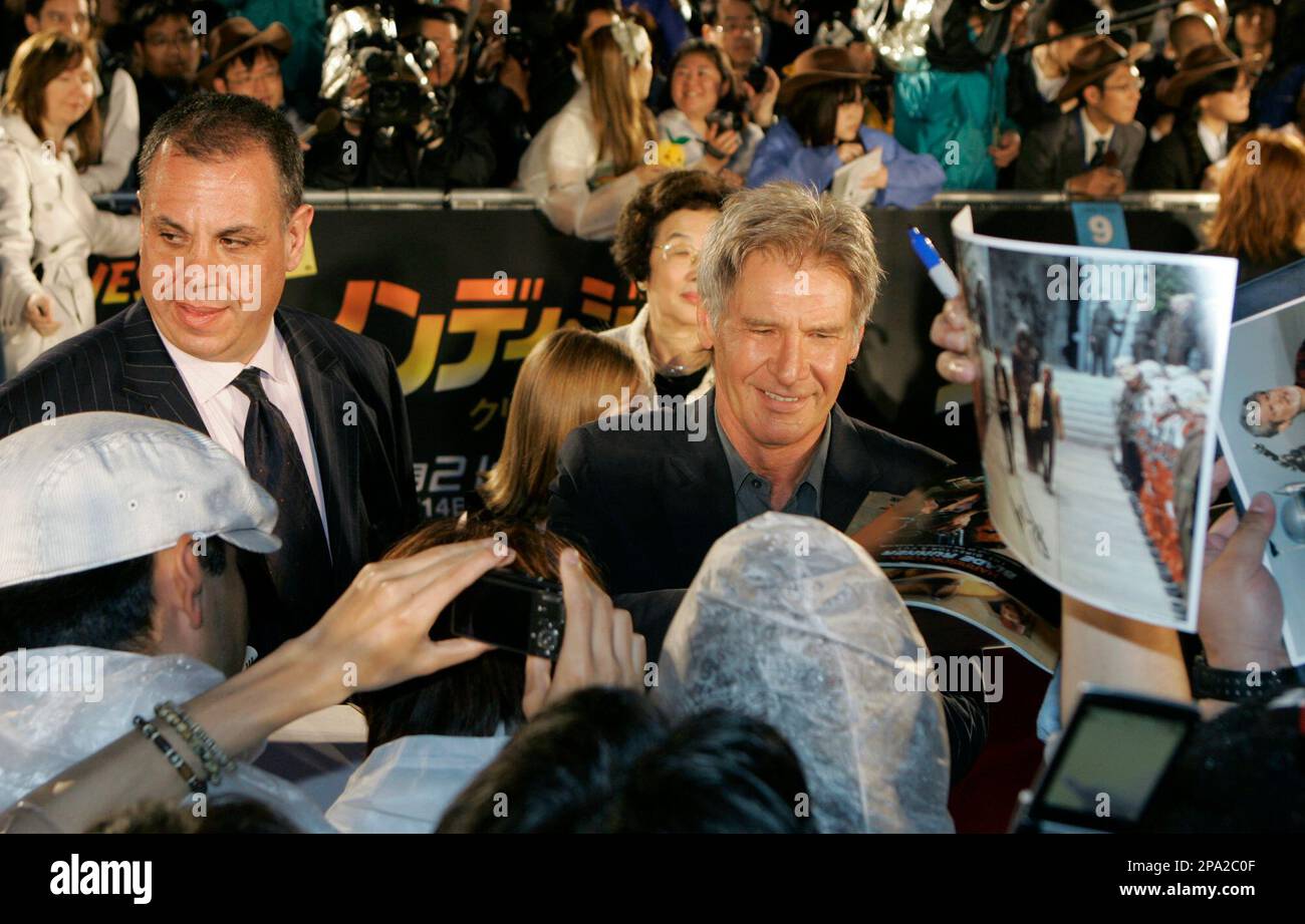 Actor Harrison Ford, center, signs autographs as he arrives for the ...