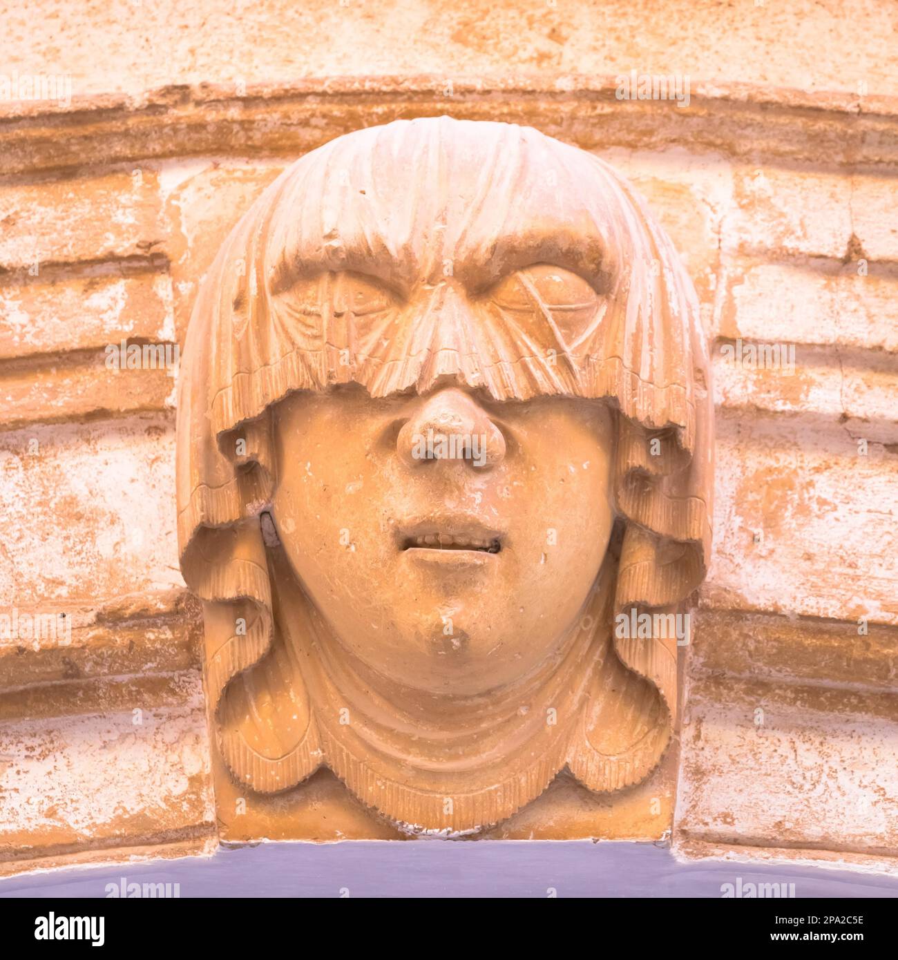 Gothic detail. Young woman portrait at the entrance of a 200 years old ...