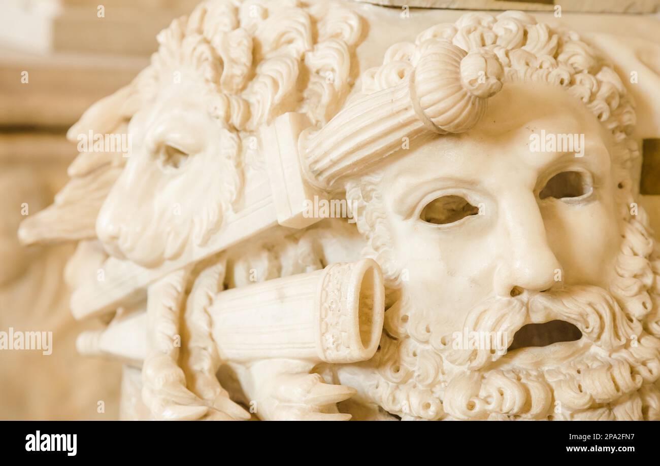 Ancient theatre mask, made of marble, located at the base of a Roman ...