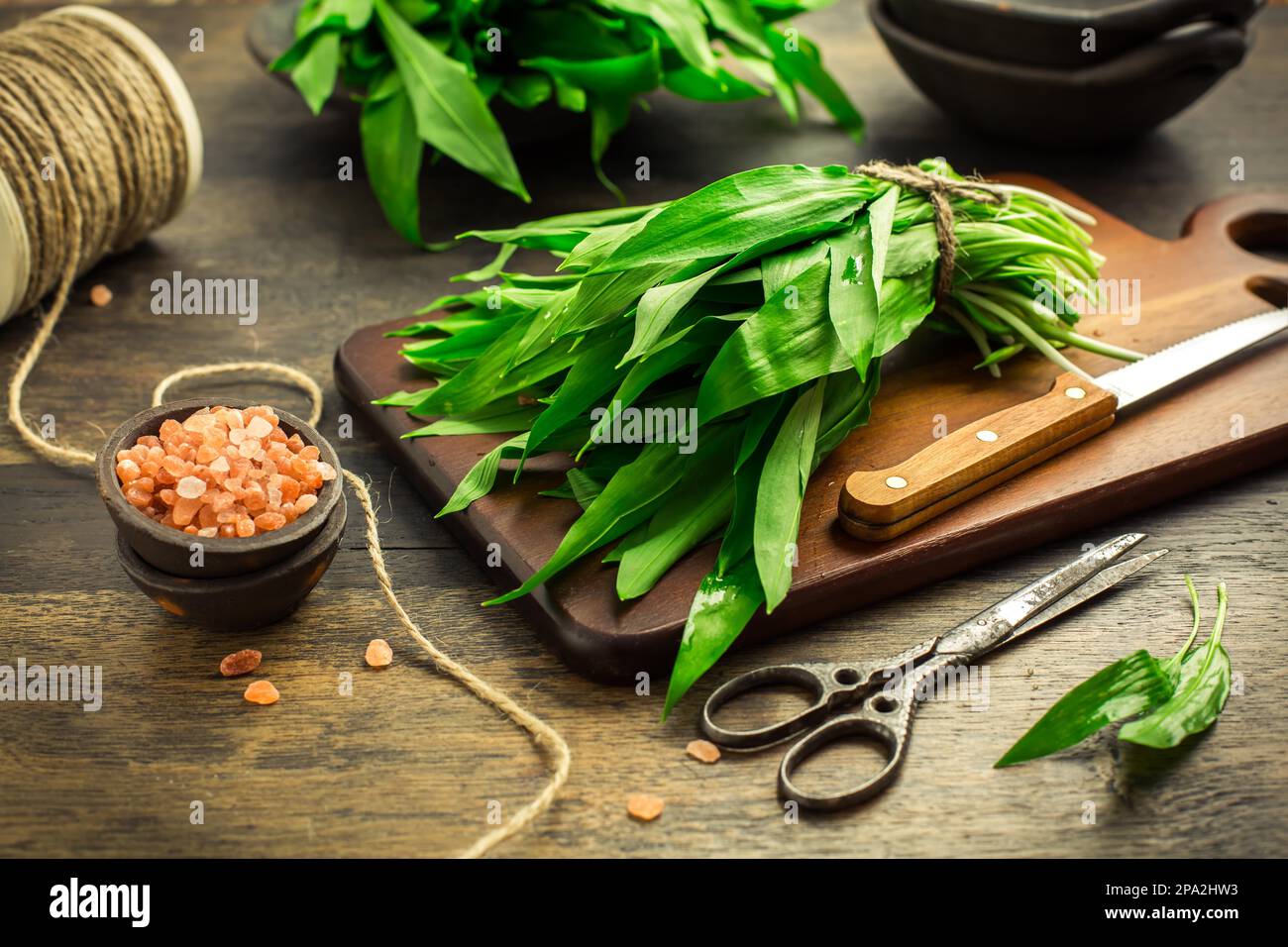Bunch Of Ramson Or Bear Leek Allium Ursinum With Pink Himalayan Salt On Cutting Board Stock