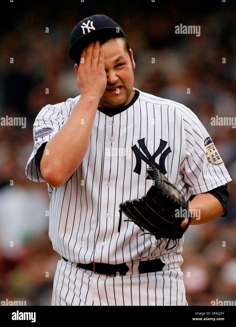 New York Yankees' Joba Chamberlain wipes his face after allowing a run ...
