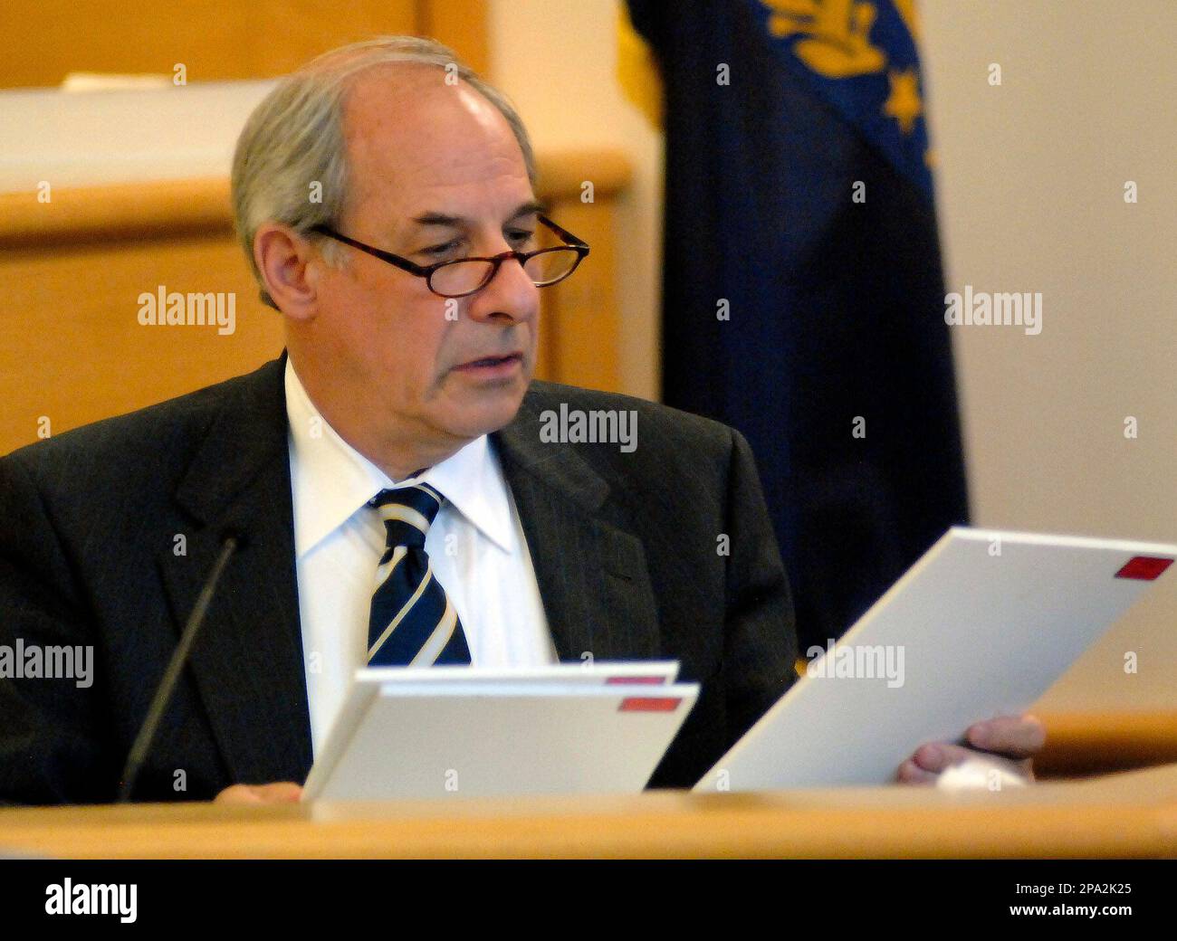 Dr. Roger Gray, looks over photographs of Kenneth Countie with wounds ...