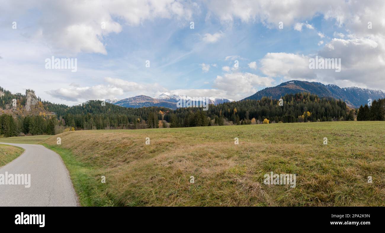 Panorama landscape view of green pastures and forest in fall colors ...