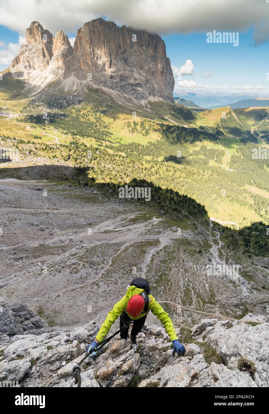 Young attractive female mountain climber in the Dolomites of Italy with ...