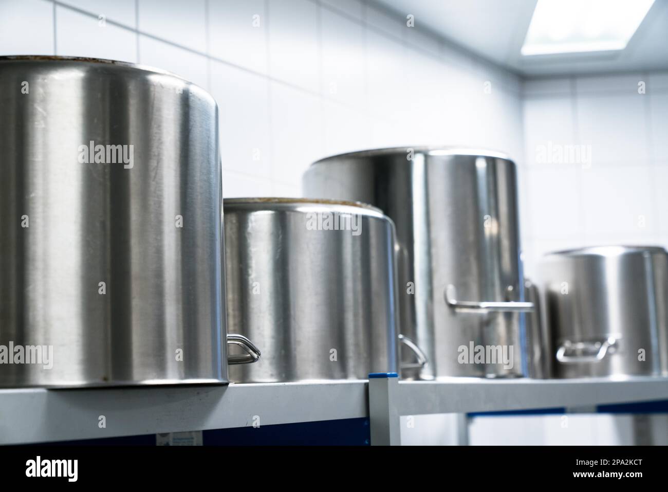 Row of large metal cooking pots in an industrial size restaurant ...
