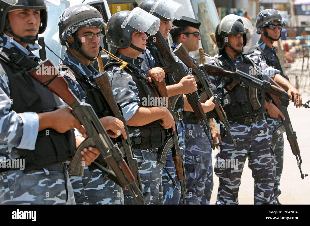Palestinian police officers take up position as they patrol the streets ...