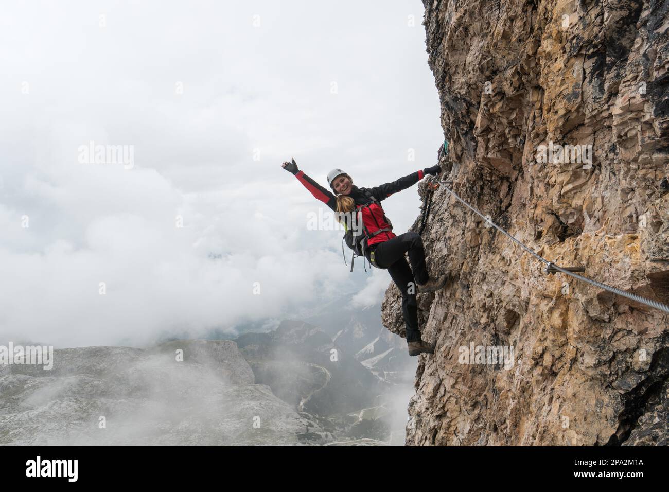 Young attractive female university student on a vertical and exposed ...