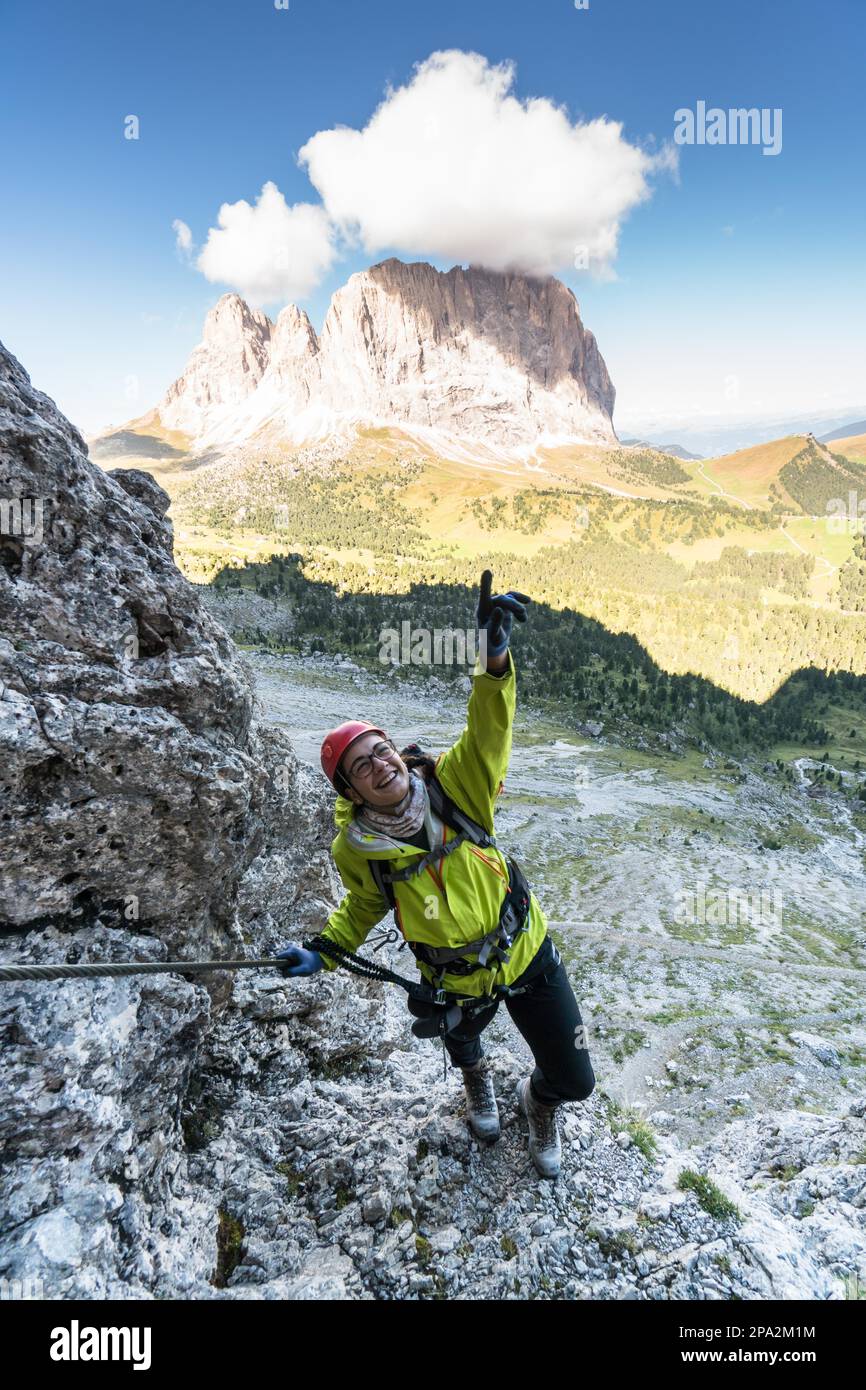Young attractive female mountain climber in the Dolomites of Italy with ...