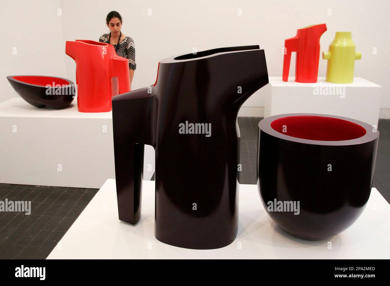 A member of the gallery staff views ceramic sculptures entitled 'The ...