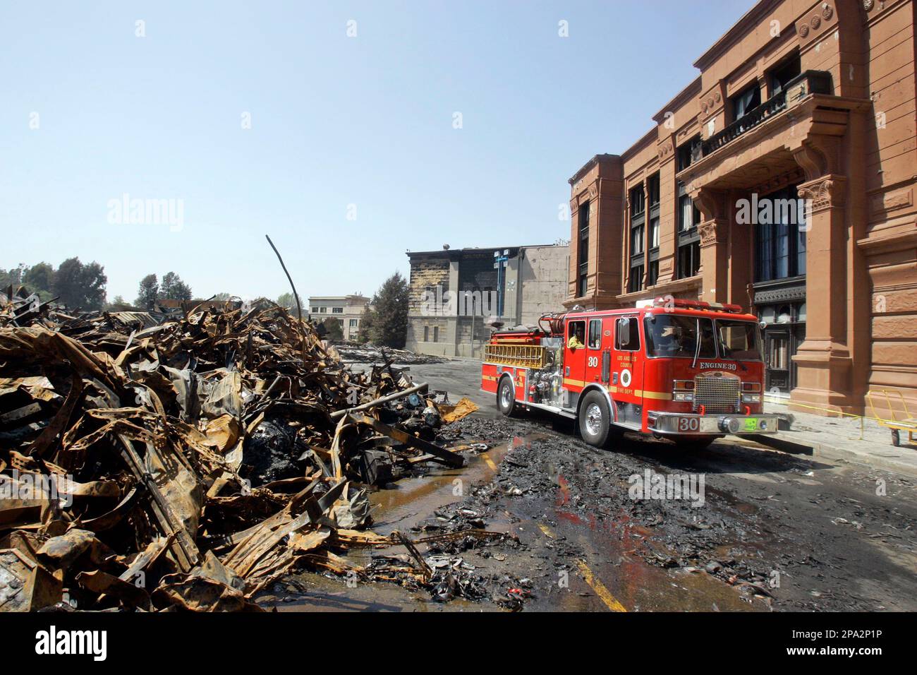 A Los Angeles County Fire truck passes a New York Street facade Monday ...