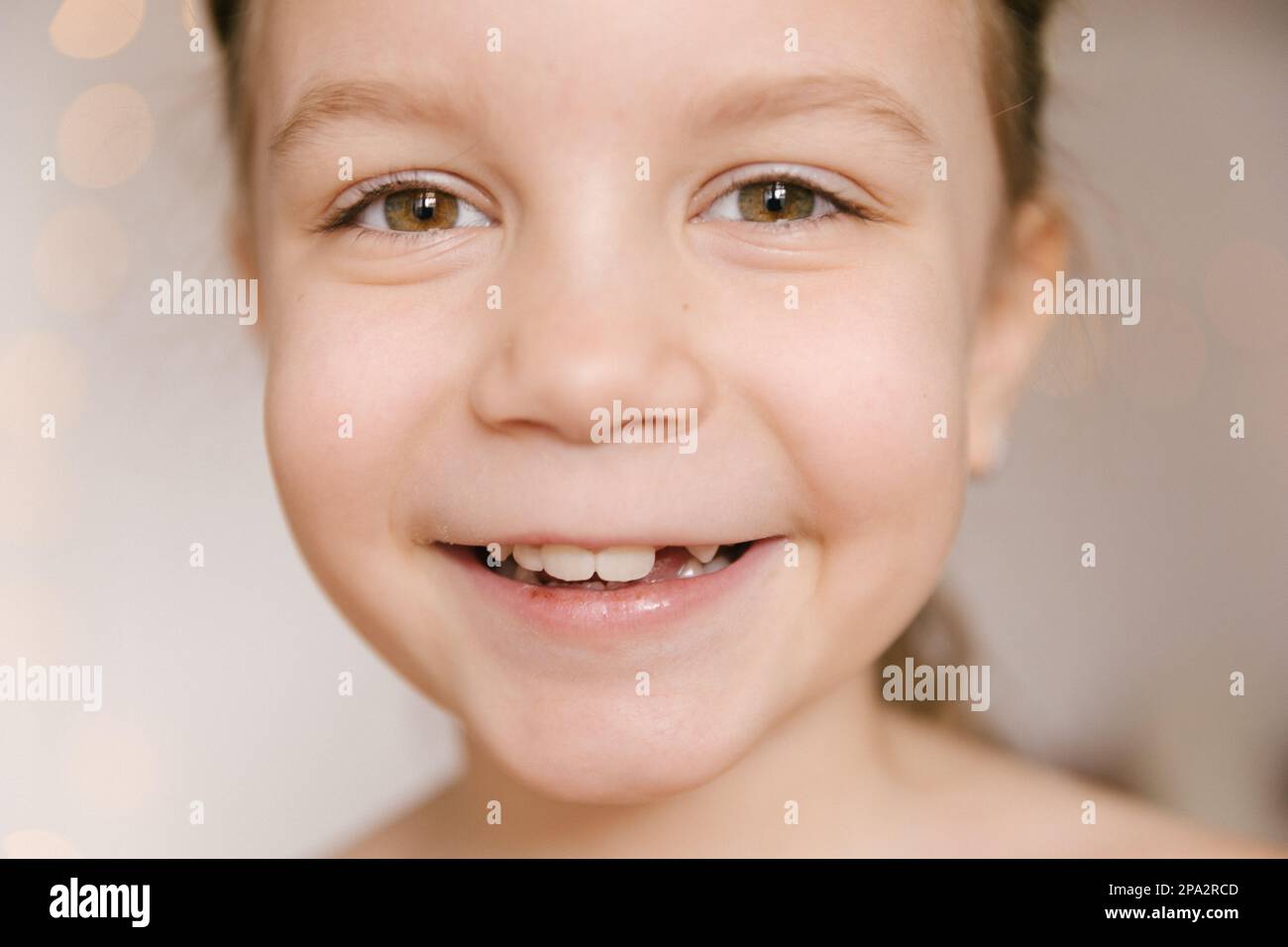 A large portrait of a girl, happy and staring into the camera, a smile ...