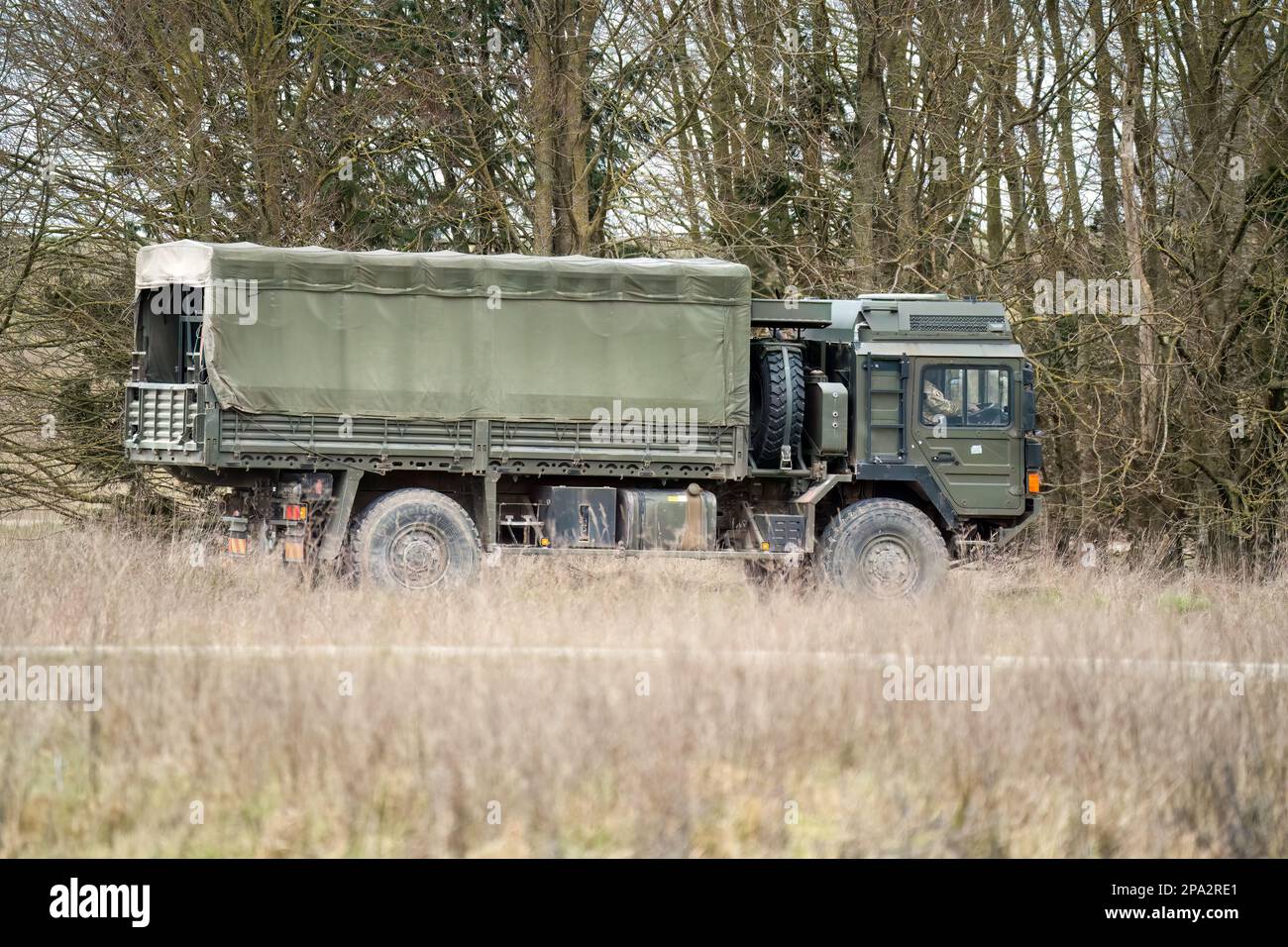 MAN SV 4x4 army logistics vehicle truck driving along a dirt track in ...