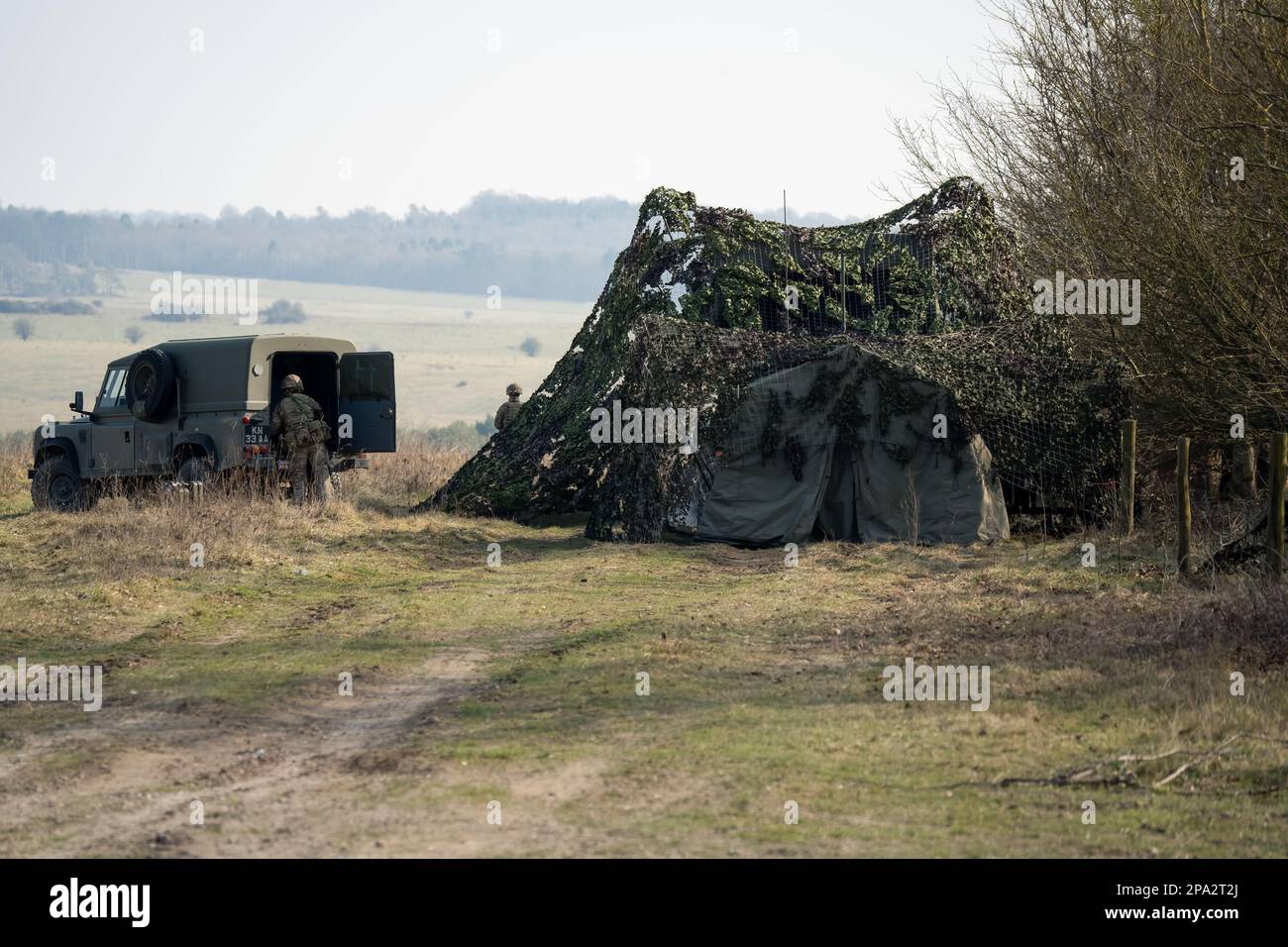 British army infantry soldiers in a lean-to vehicle tent, Wiltshire UK ...