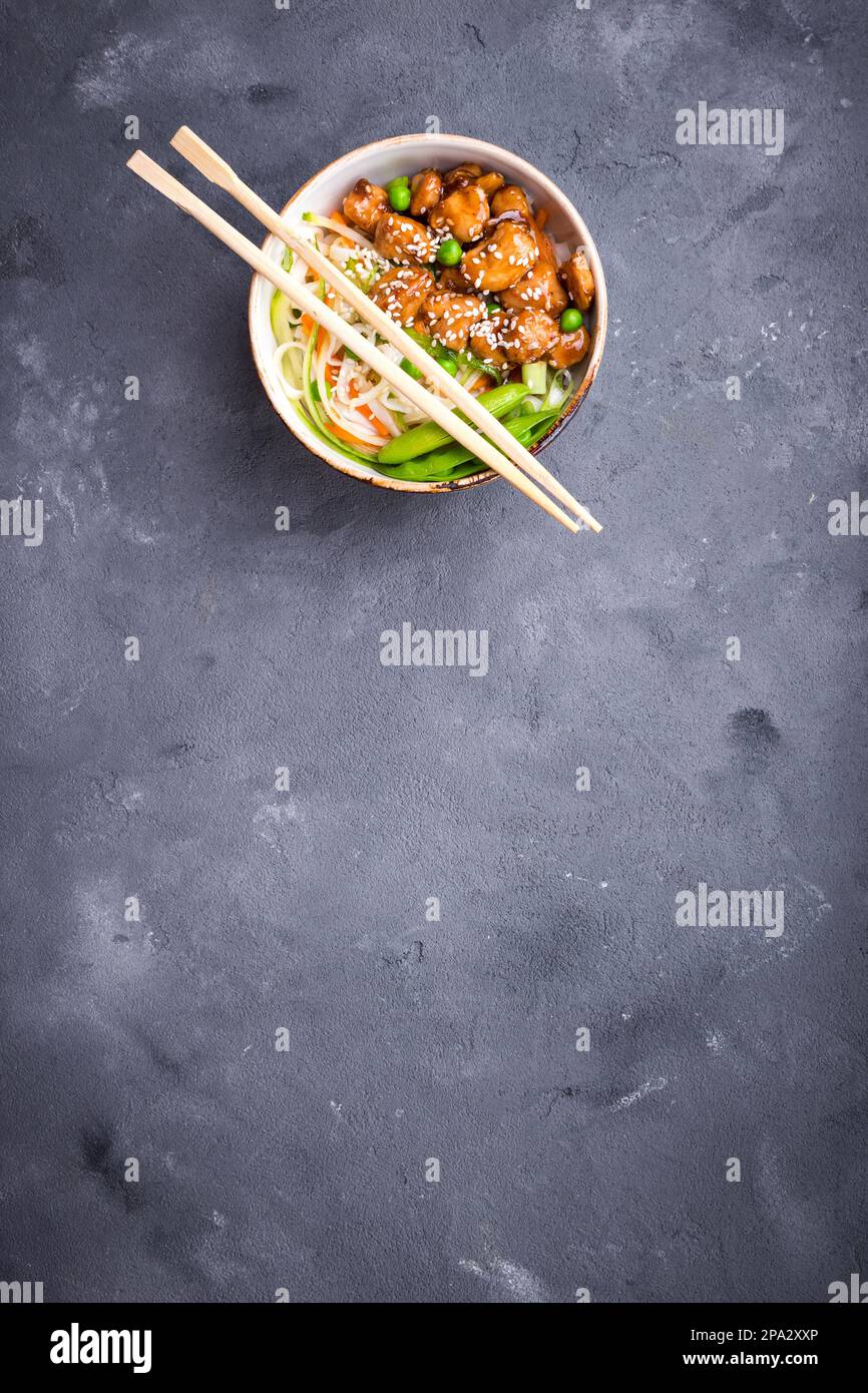 Asian style noodles with teriyaki chicken, vegetables and green peas ...