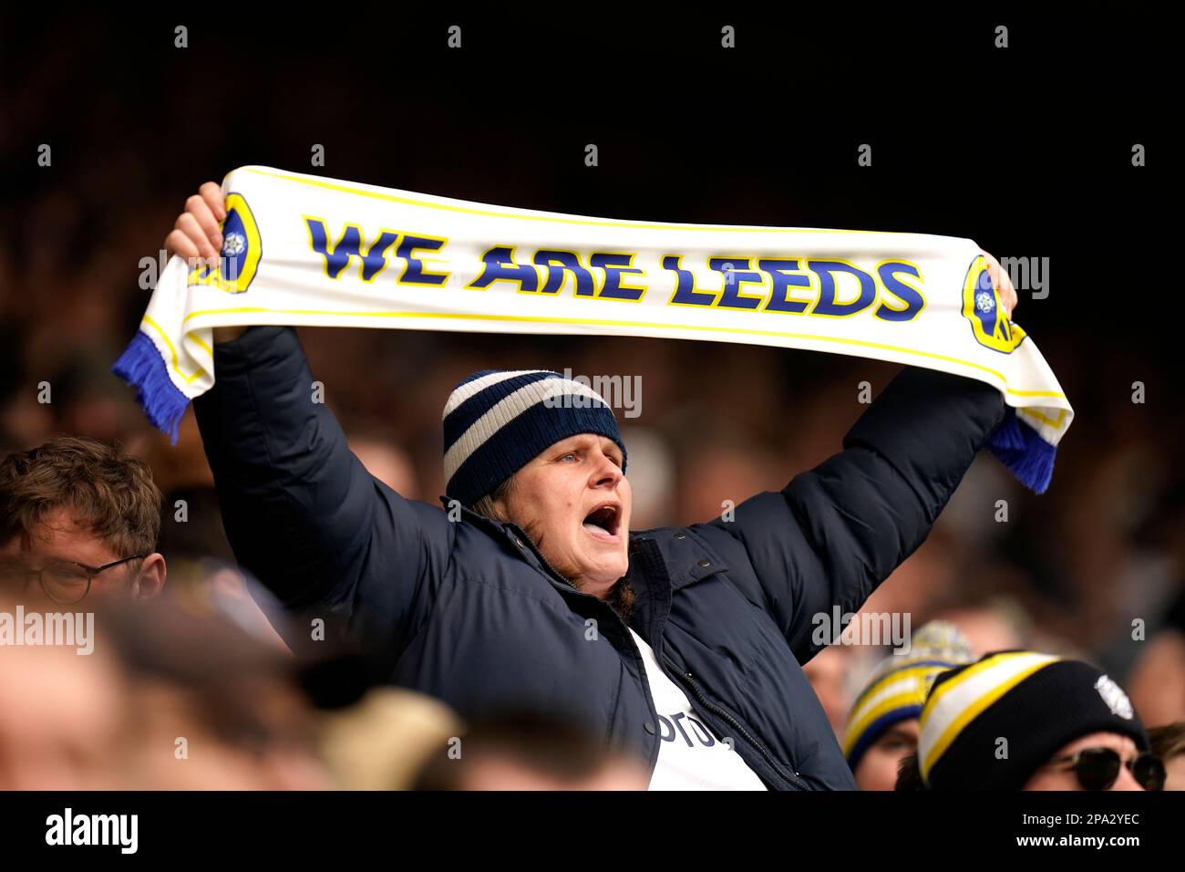 A Leeds United fan holds up a scarf prior to kick off in the Premier League match at Elland Road Leeds. Picture date Saturday March 11 2023 Stock Photo Alamy