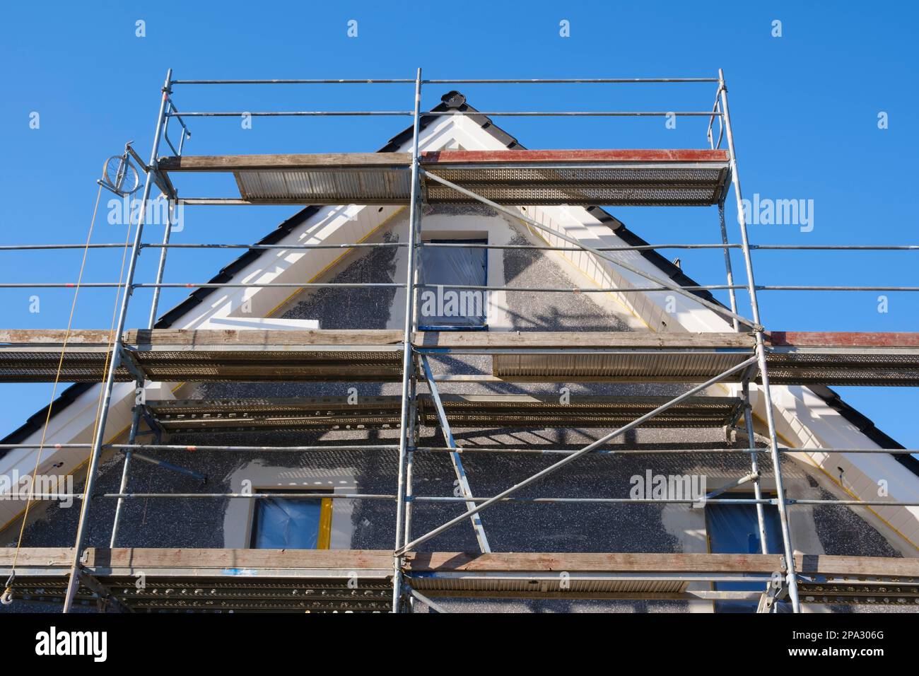House gable with scaffolding, building site in a new housing estate ...