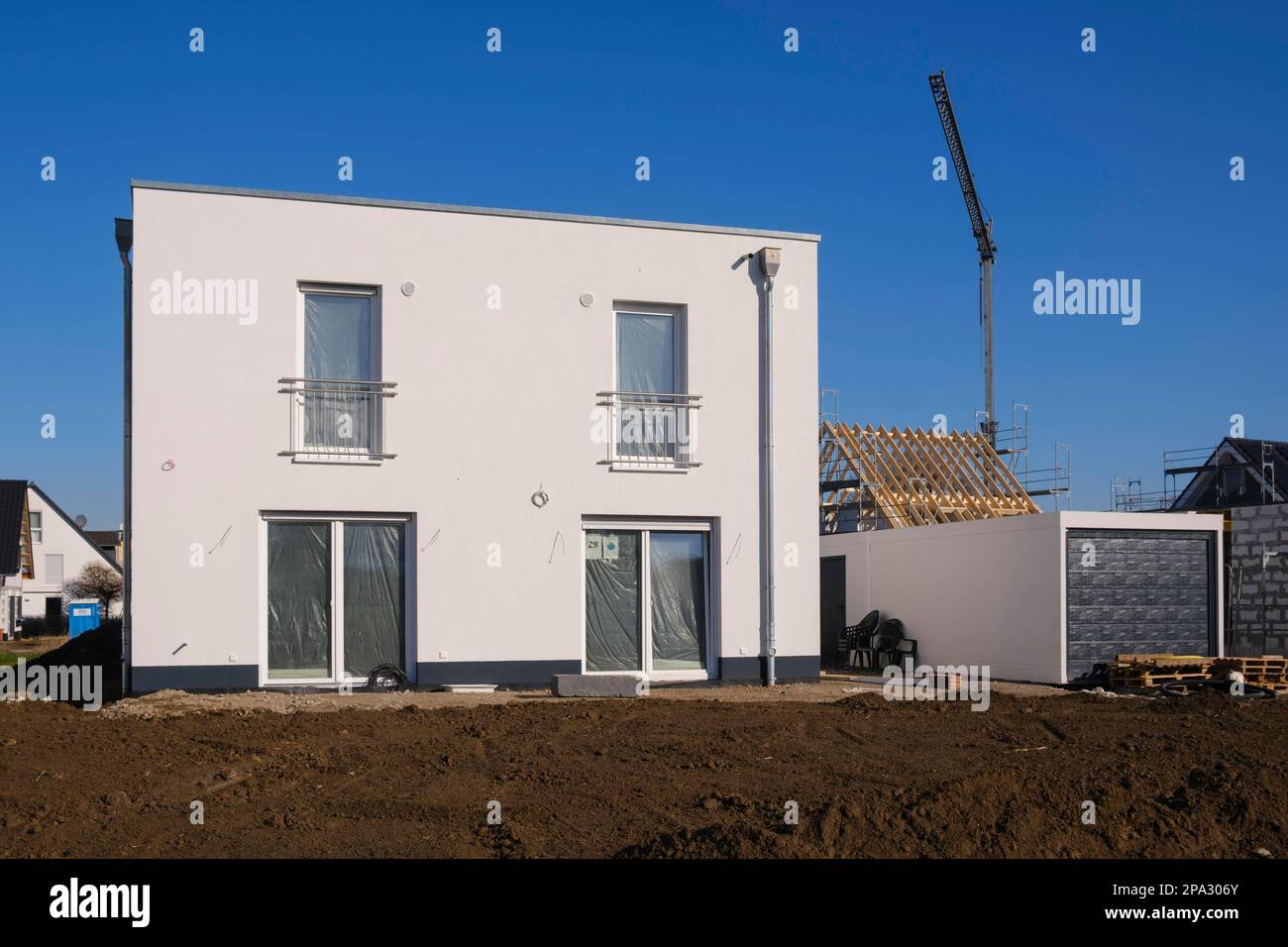 Residential building with flat roof, construction site in a new housing ...