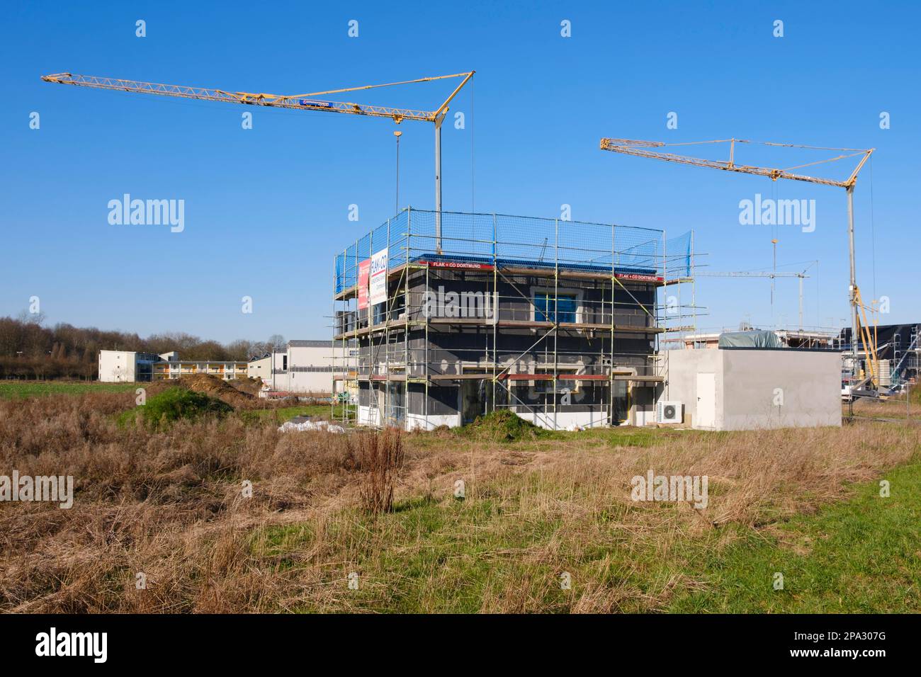 Residential building with scaffolding and flat roof, construction site ...