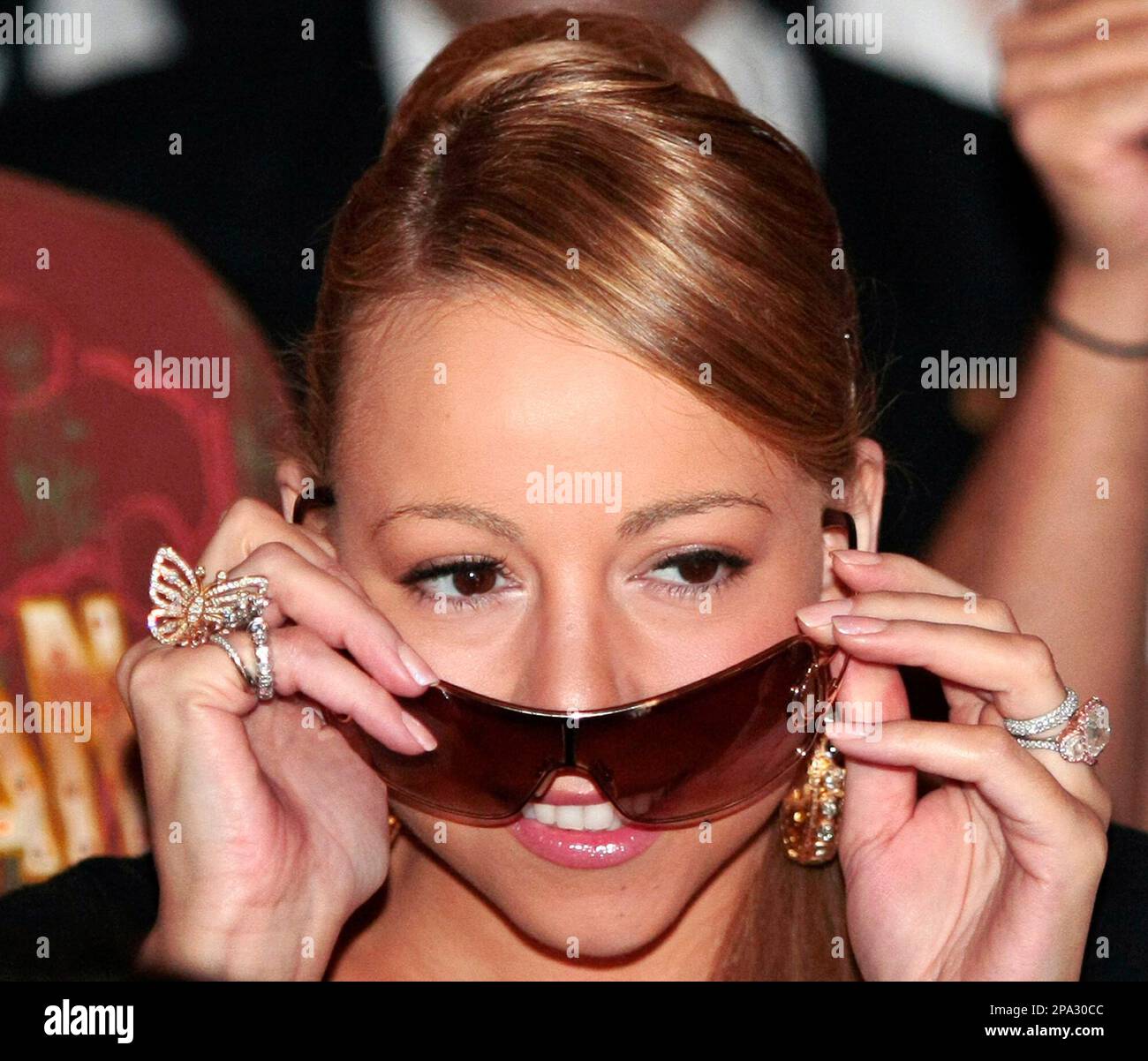Mariah Carey adjusts her glasses as she arrives at a Tokyo shopping ...