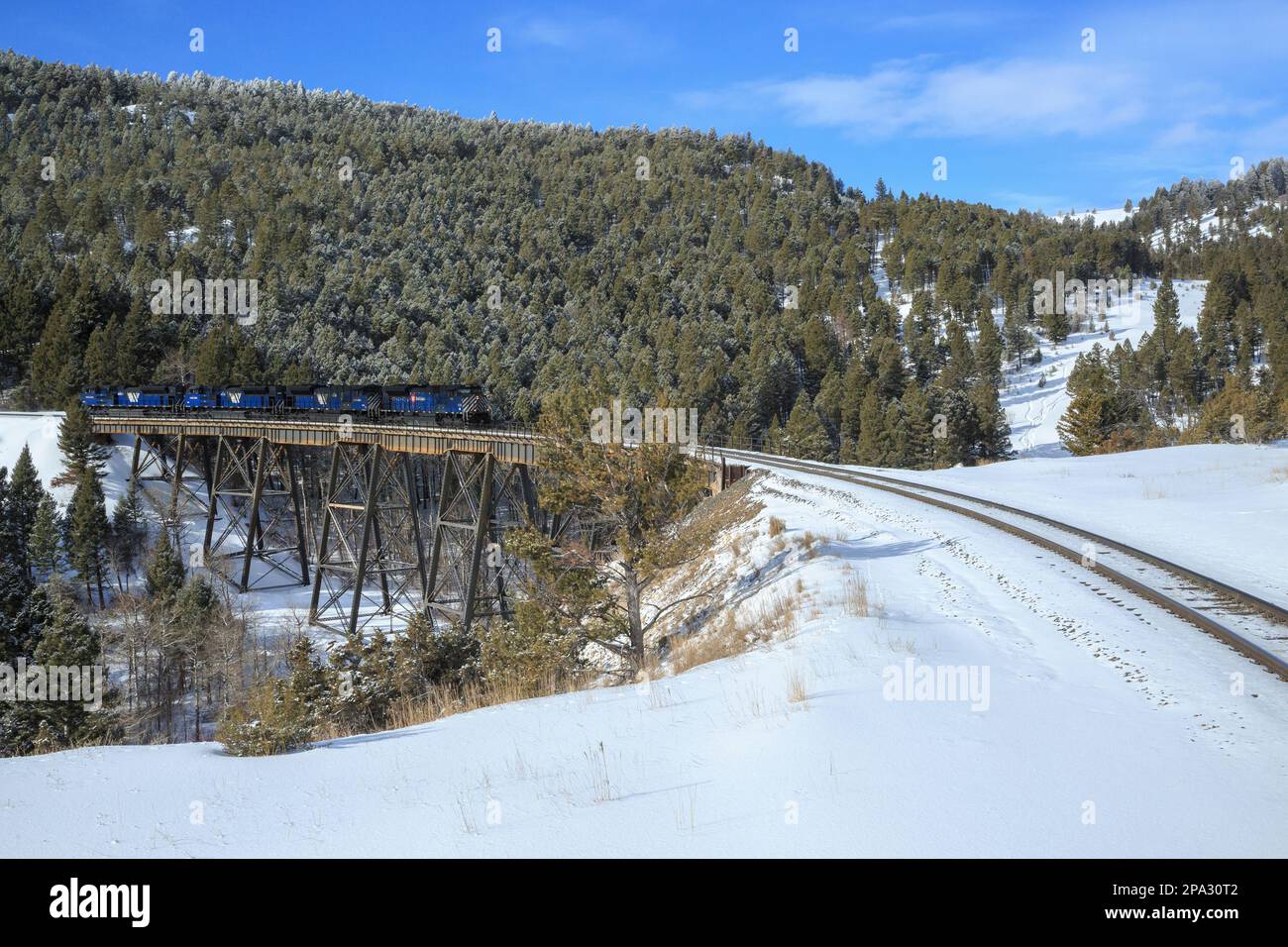 helper engines in winter traveling over the train trestle near austin ...