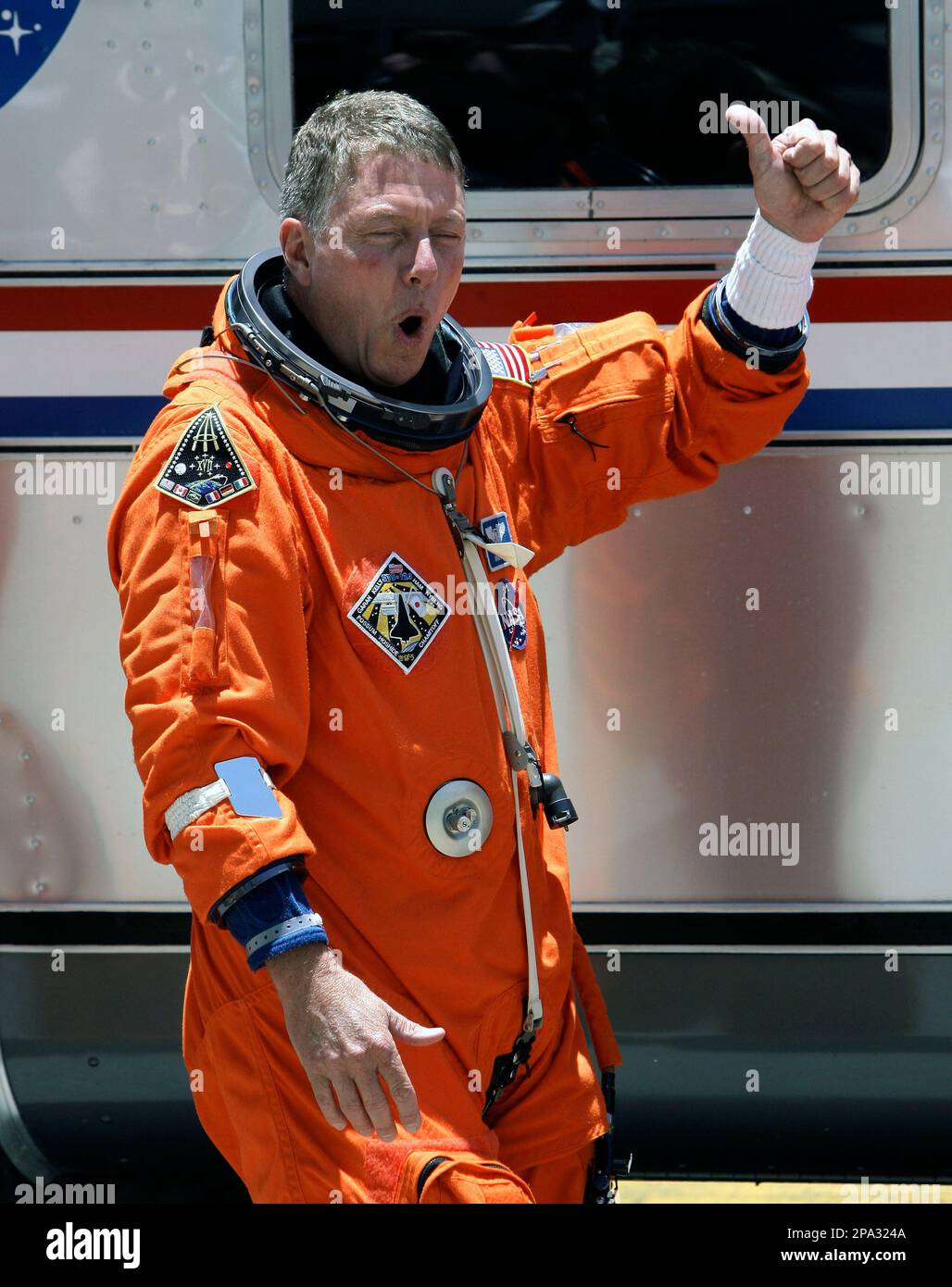 Space shuttle Discovery mission specialist Mike Fossum gives thumbs up ...
