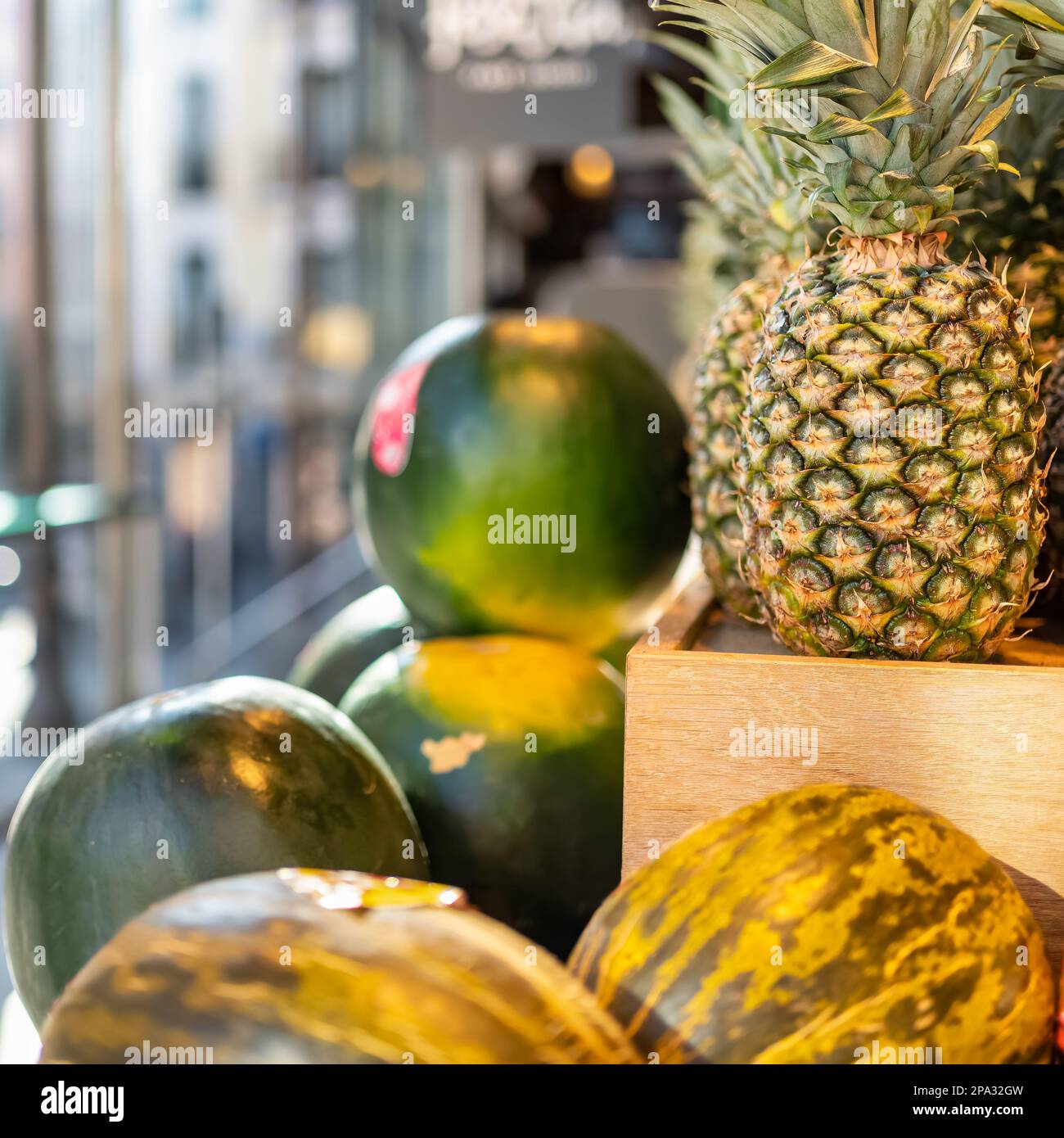 Pineapples and melons exhibited for sale in a fruit shop in Madrid ...