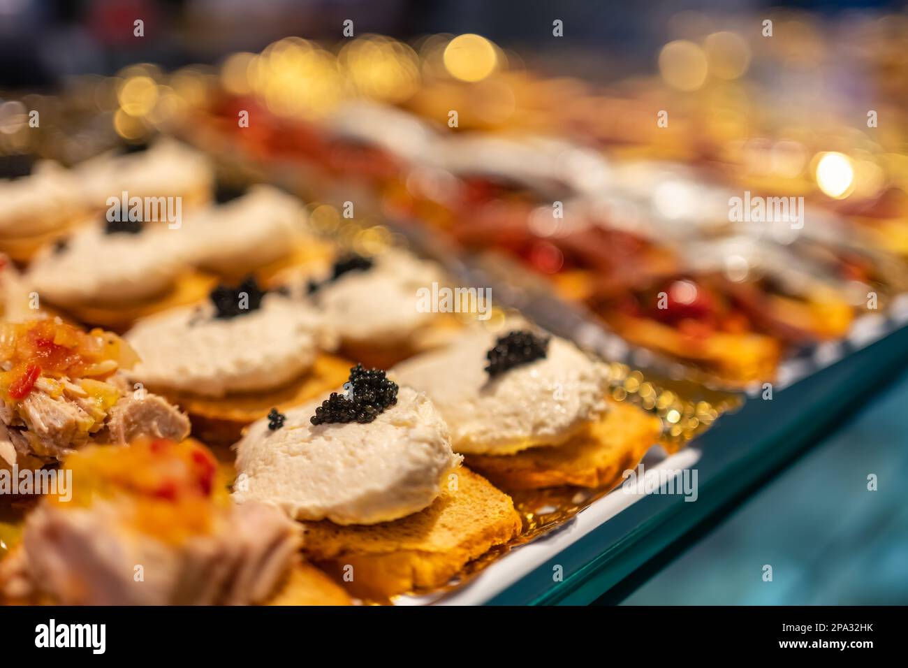 Tuna and caviar snacks displayed at a ready-to-eat counter, Mercado de ...