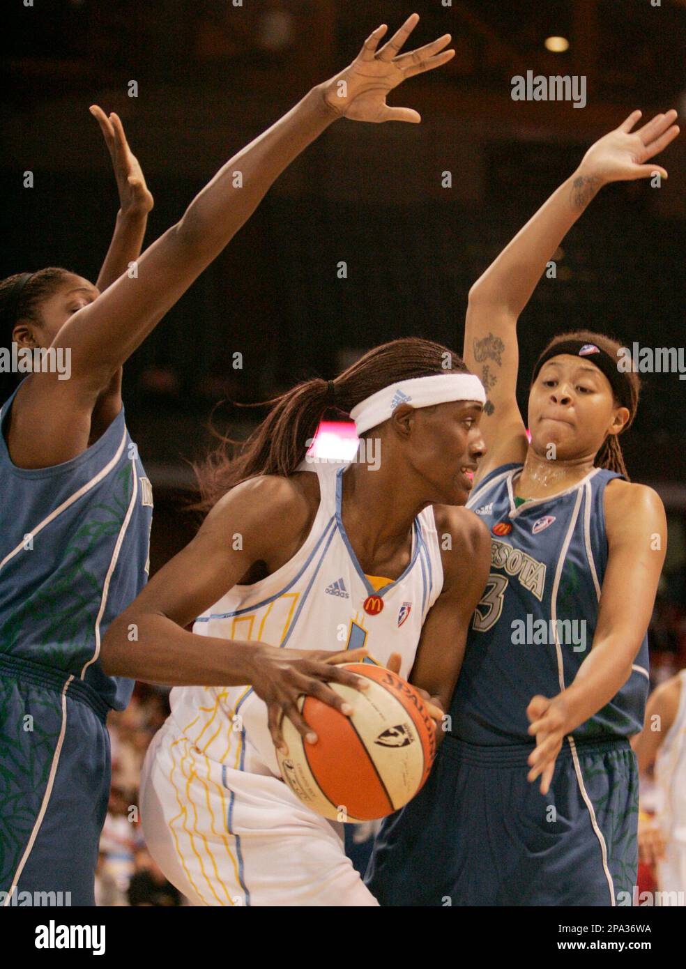 Chicago Sky's Sylvia Fowles, center, looks to pass between Minnesota ...