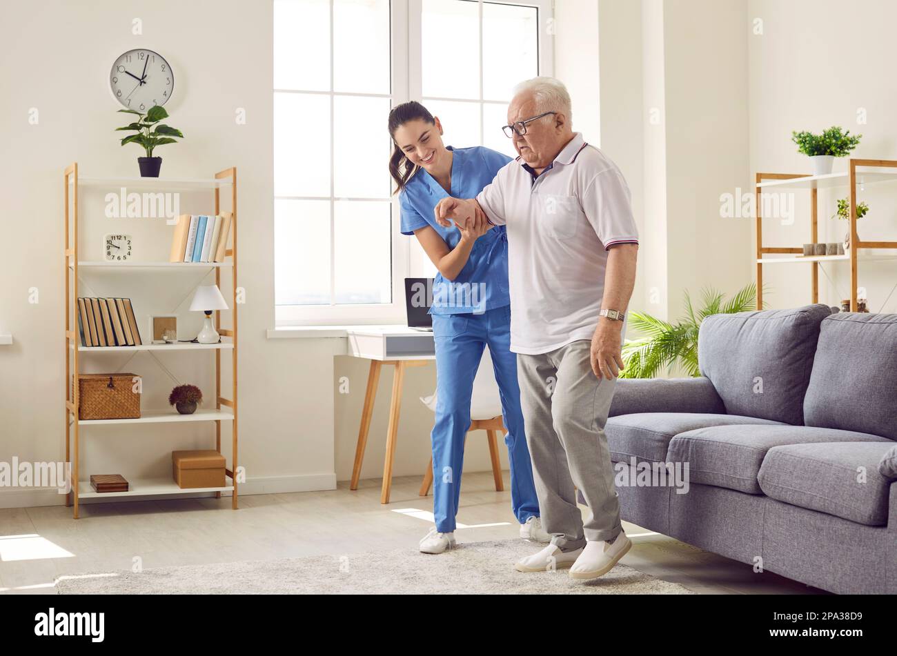 Young man helping older man to walk hi-res stock photography and images ...