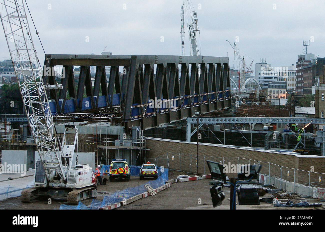 Workers are seen inspecting a 1,300-tonne bridge, part of the East ...