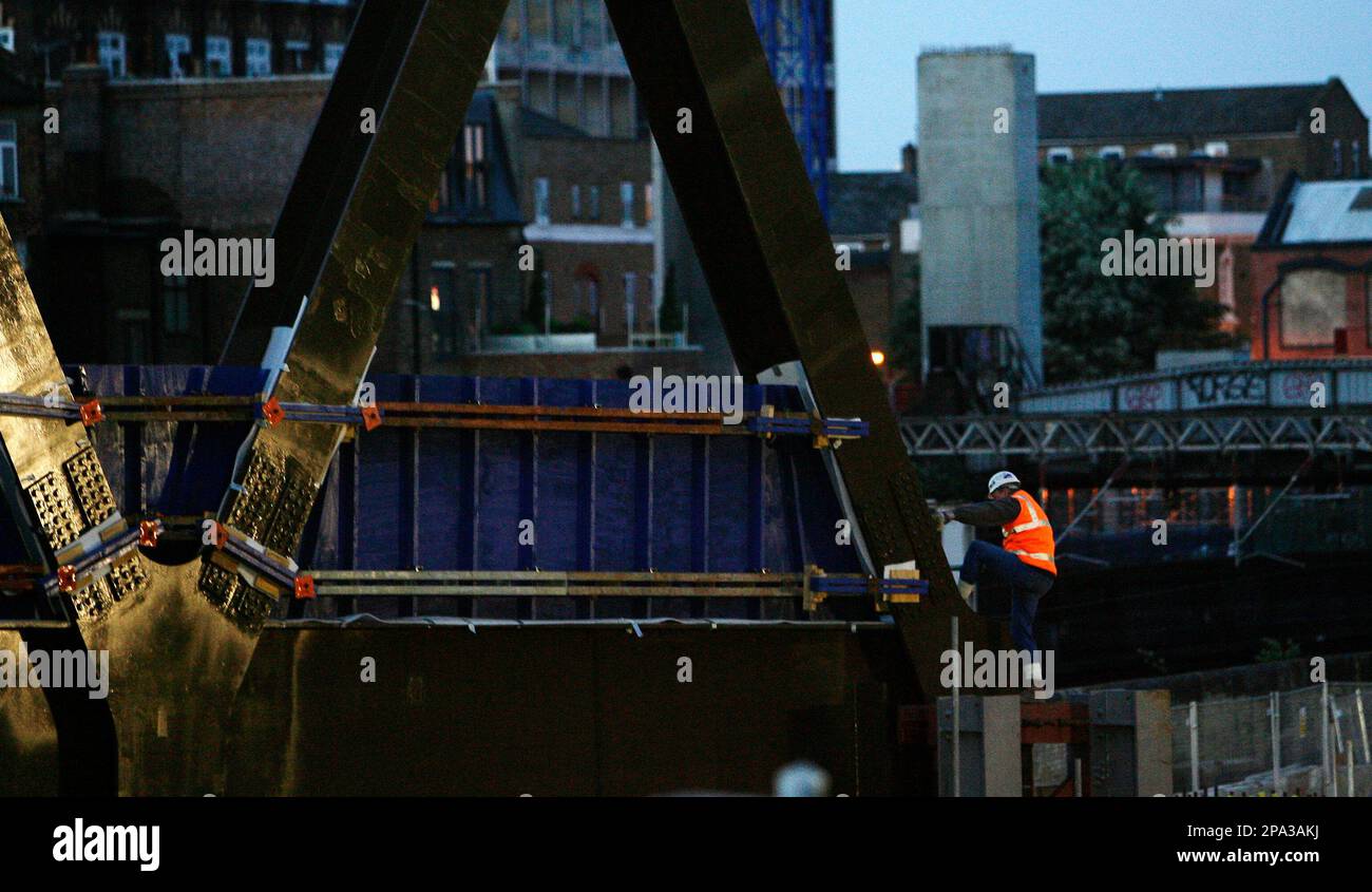 Workers are seen inspecting a 1,300-tonne bridge, part of the East ...