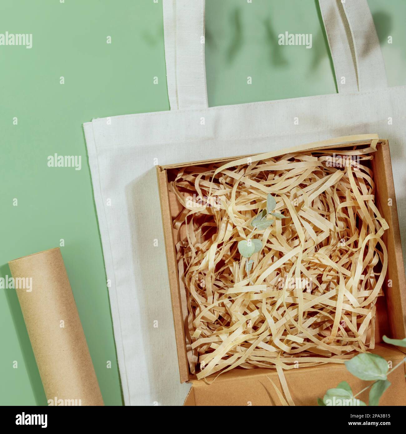 Eco friendly packaging concept. Cardboard box with shredded paper on ...