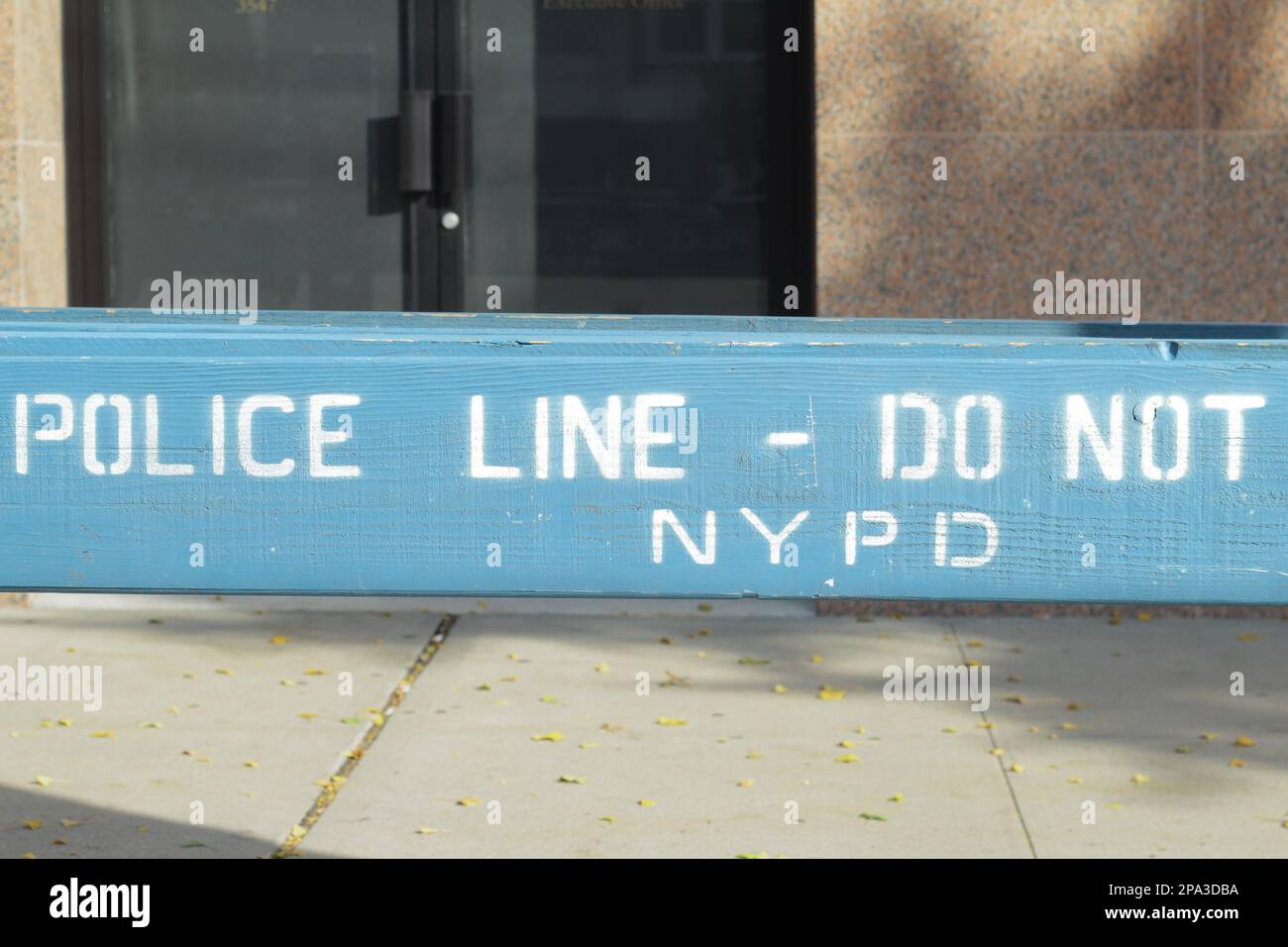 Police line, do not cross, NYPD blue wooden barricade on closed street ...