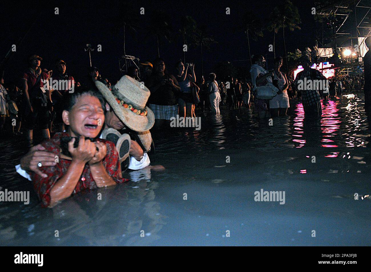 Lydia Cornett of Honolulu is comforted by a stranger while she cried ...