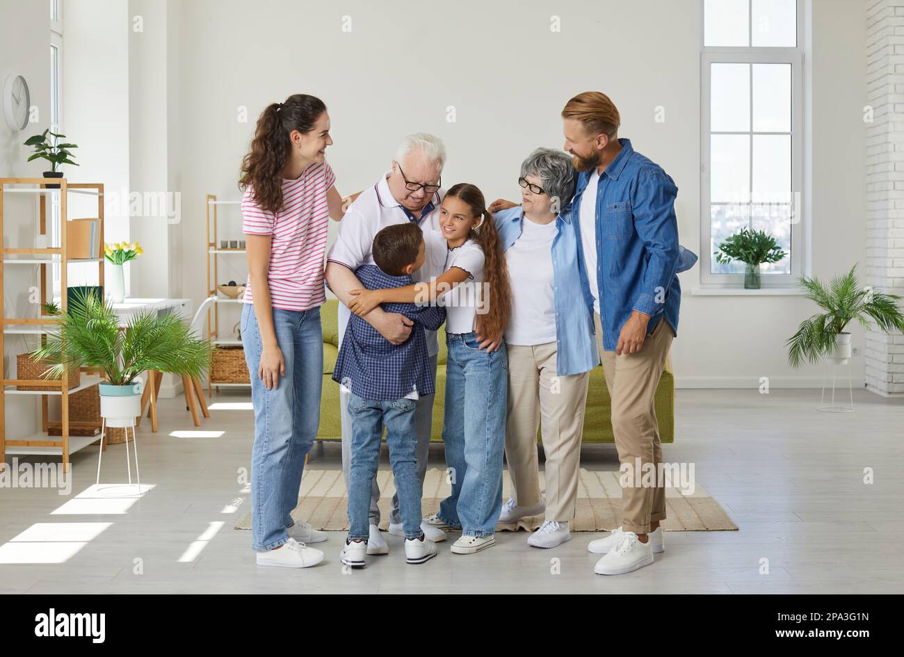 Big friendly family from youngest generation to oldest hugs and ...