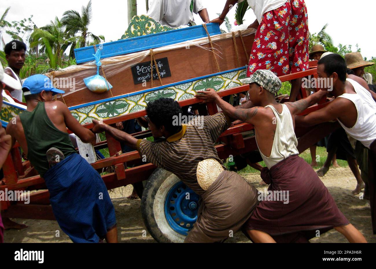Friends push the coffin of a cyclone victim who died in hospital from a ...
