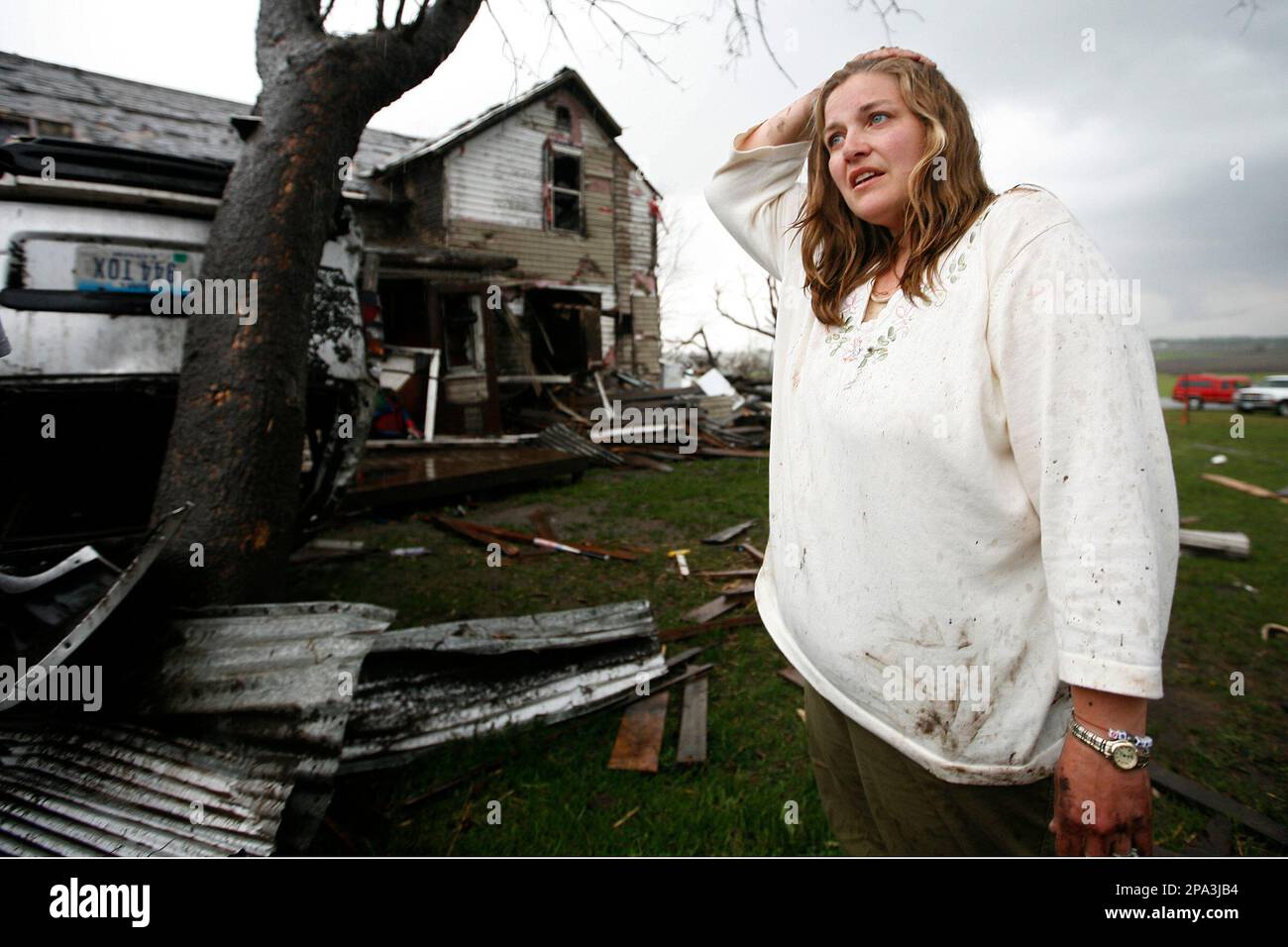 Julie Rottinghaus looks on while surveying the damage to her Dunkerton ...